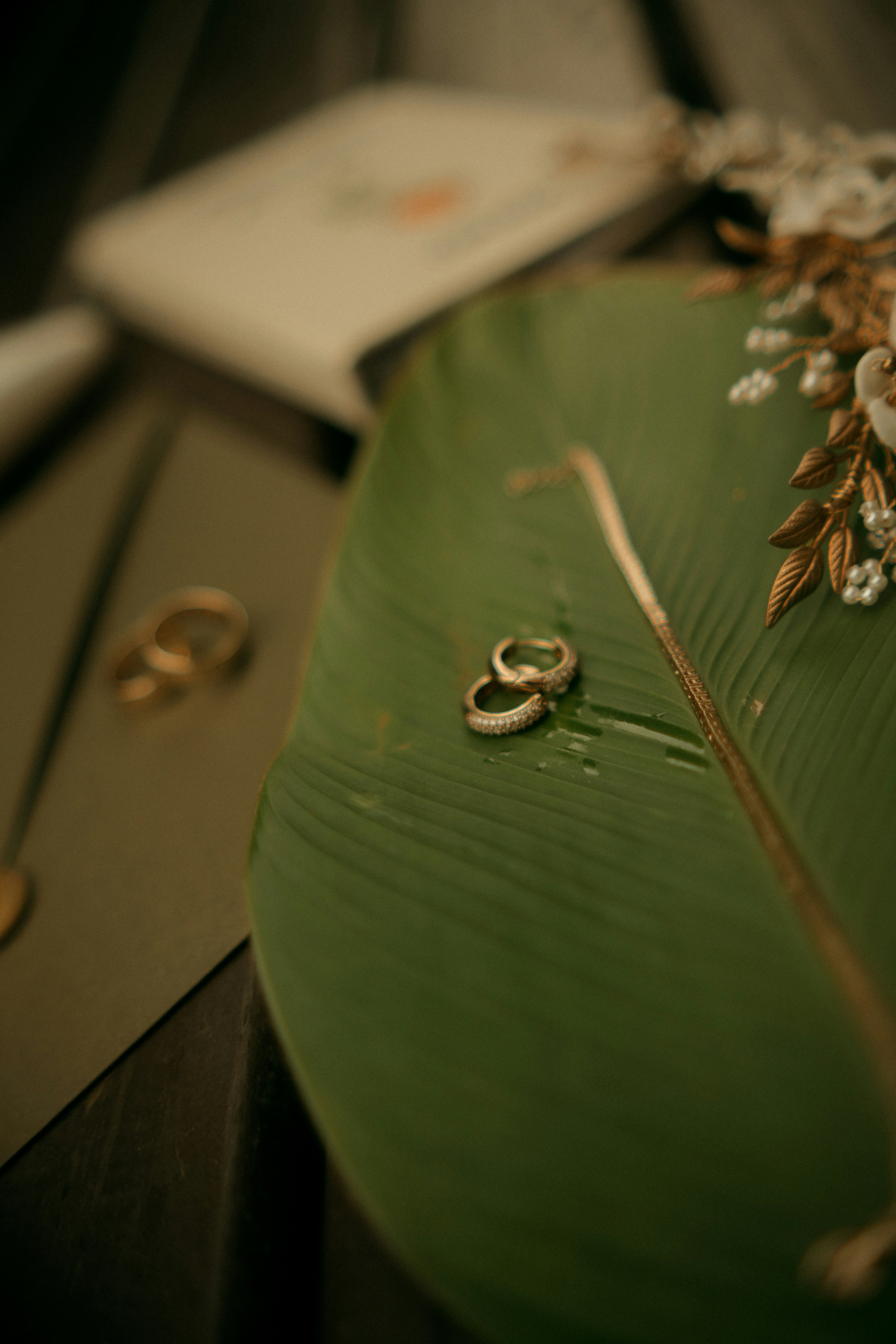 Blooming Rings on a Leaf: A Quiet Vignette of Wedding Details