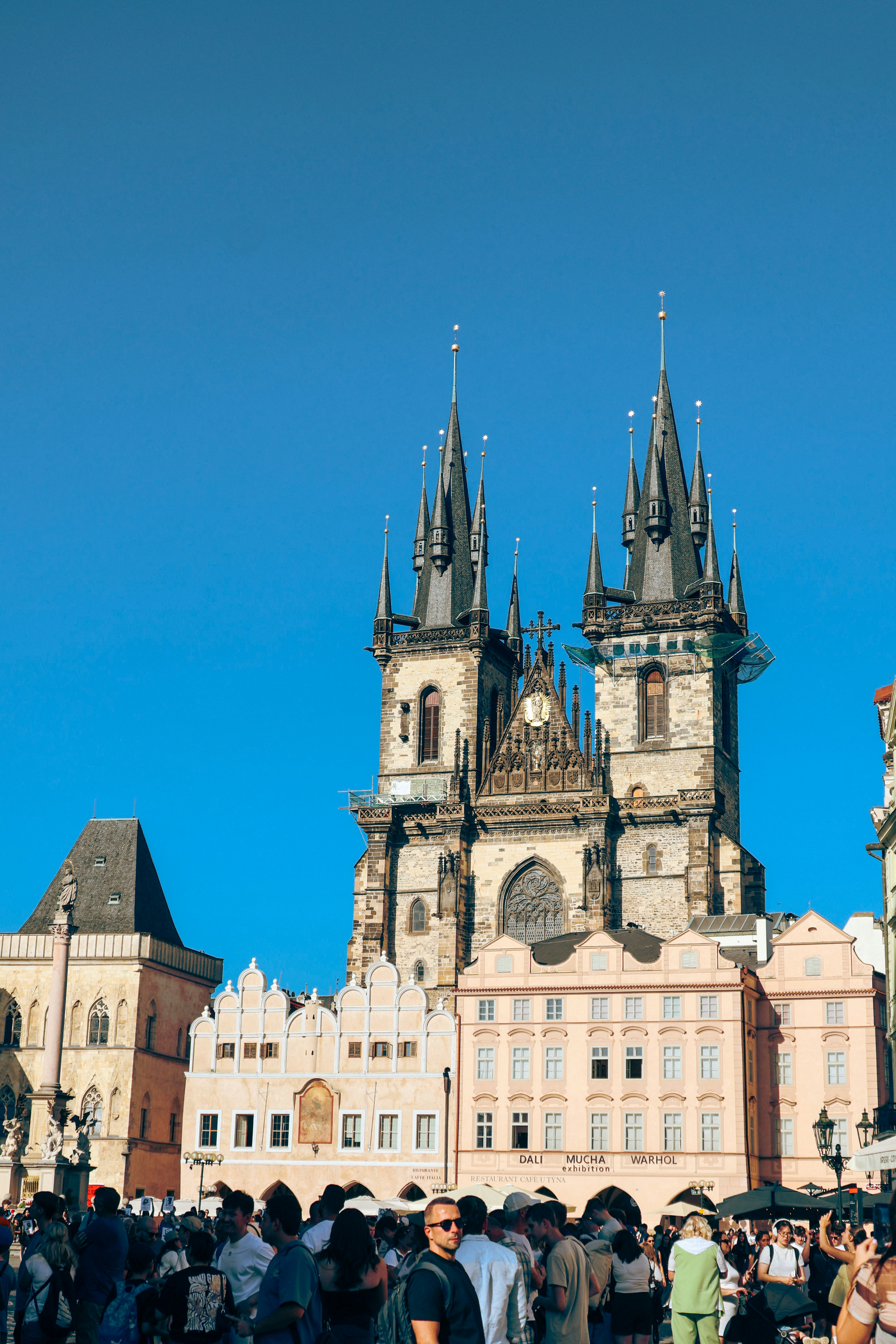Gothic Cathedral Towers Rise Above a Crowded Old Town Square