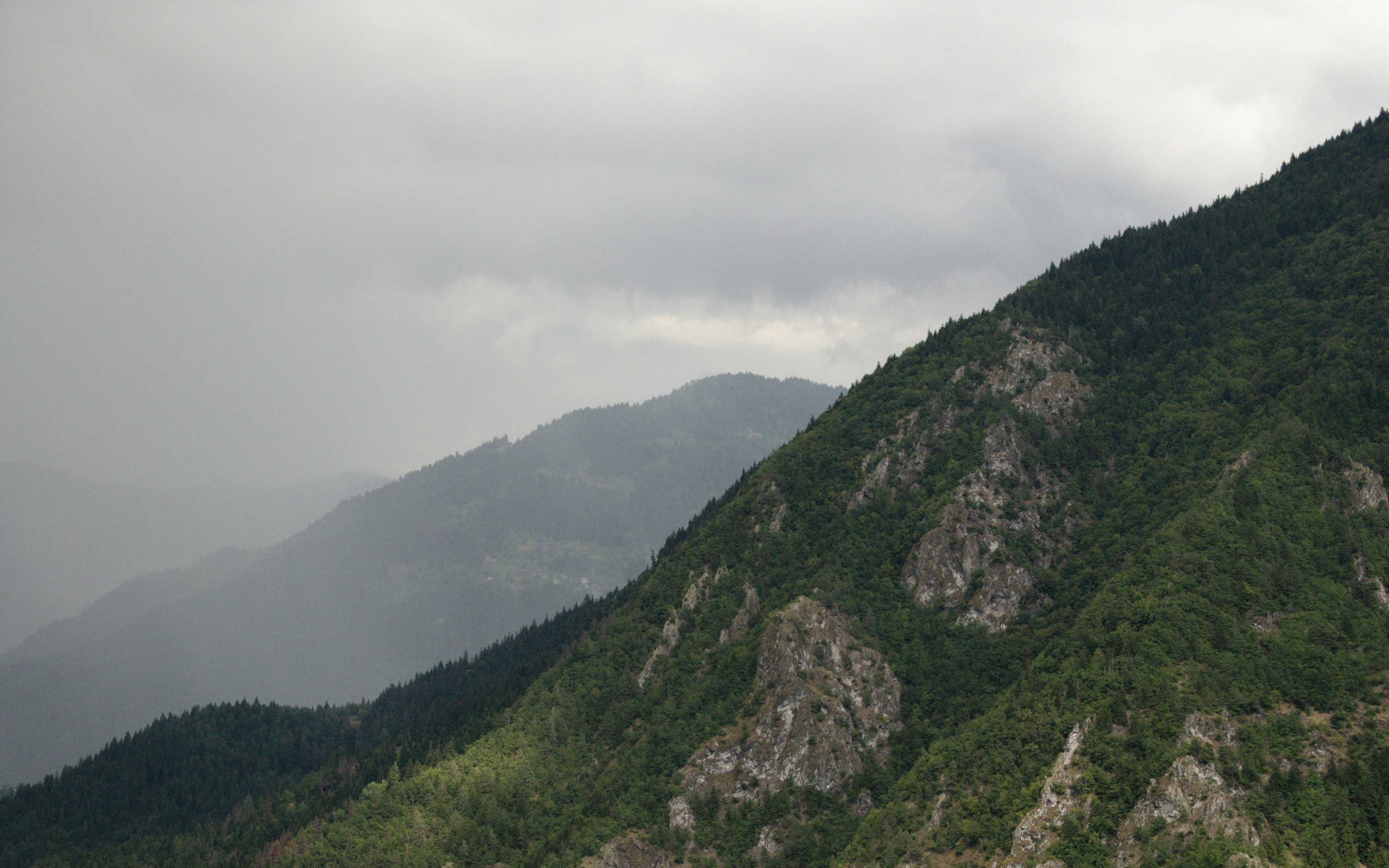 Ridgeline Quiet: A Misty Cascade Between Mountain Ridges