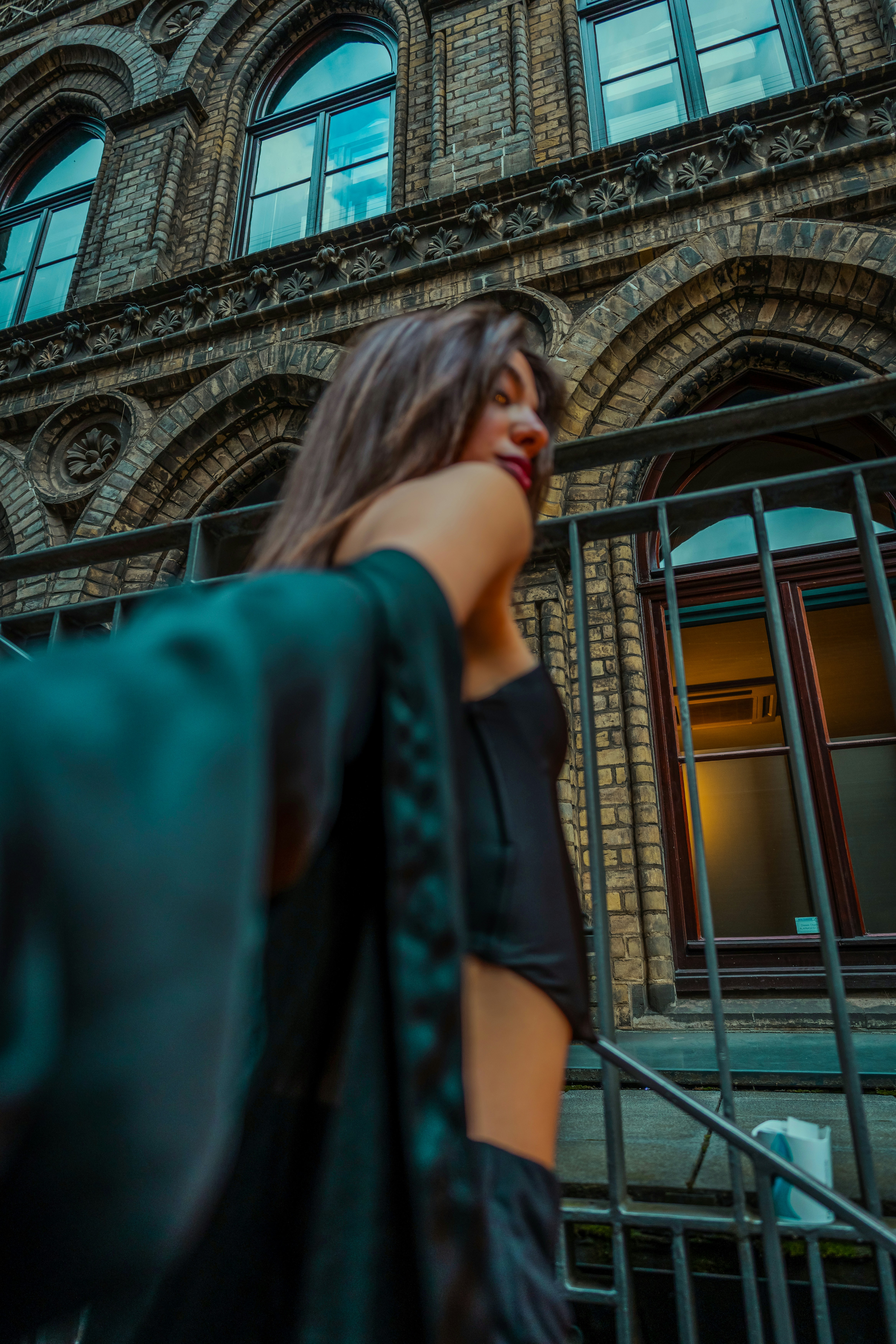 Urban Portrait with Lush Fabric and Historic Brickwork