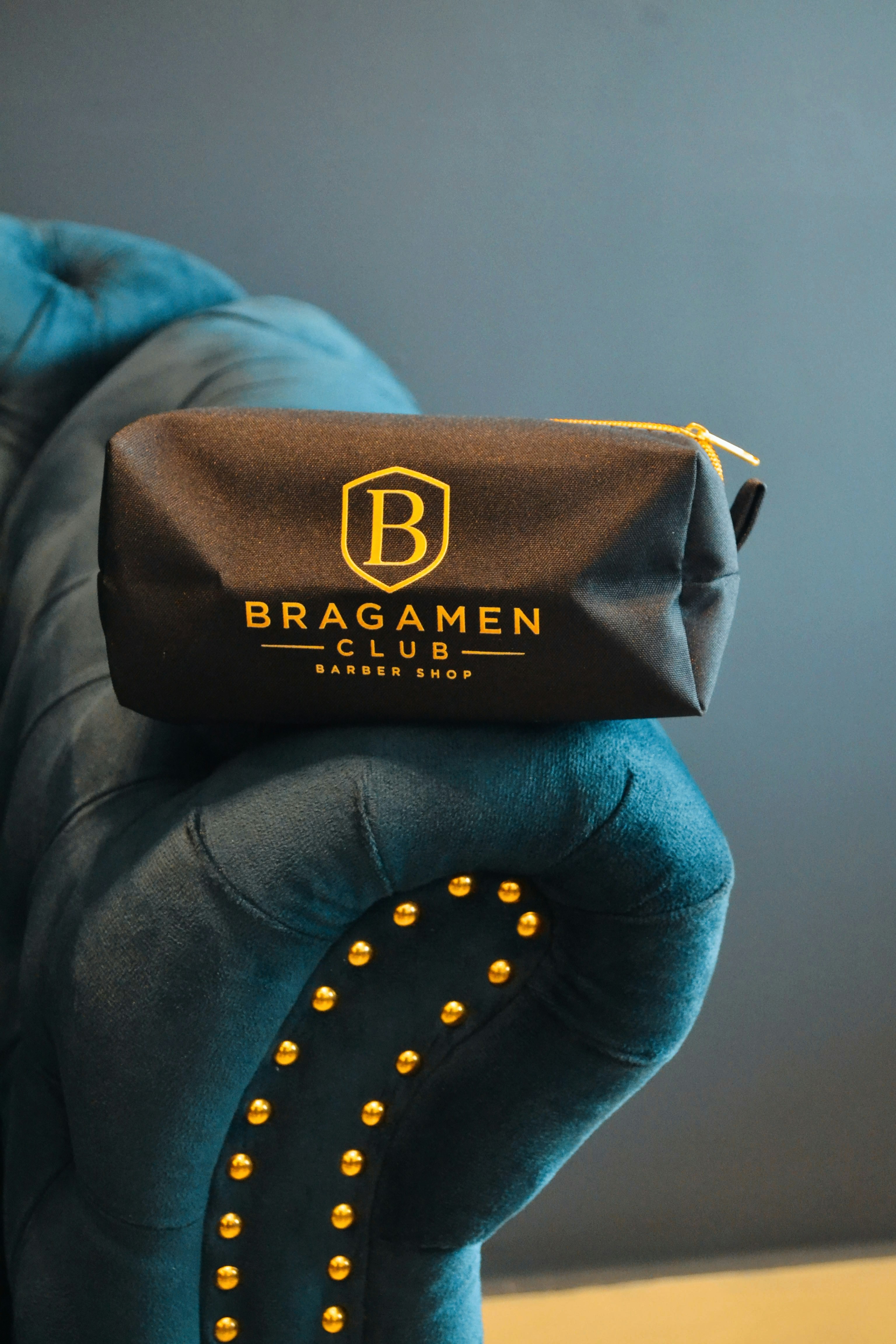 Bragamen pouch resting on a velvet chair