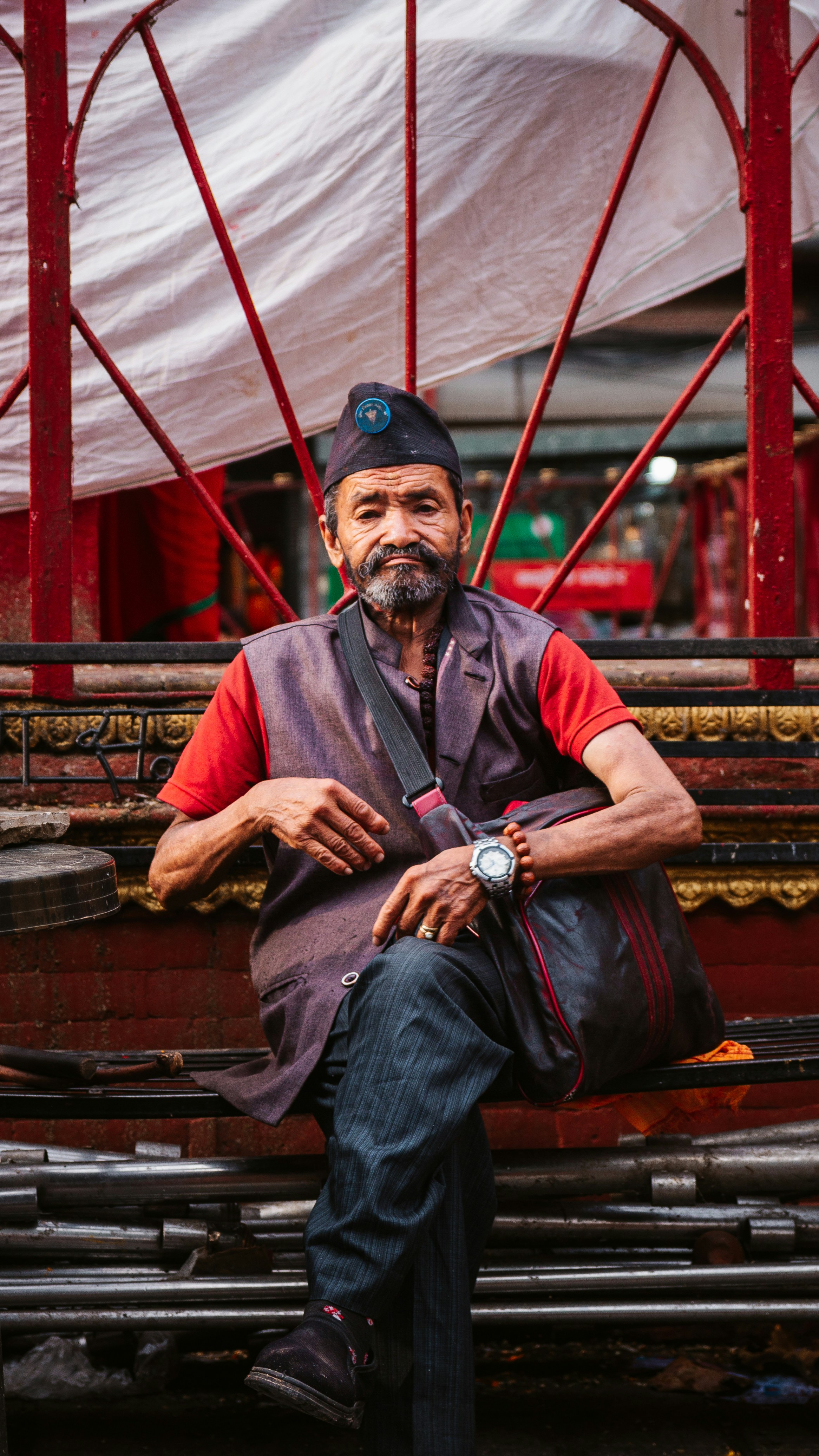 An elderly man wearing a traditional Dhaka topi.