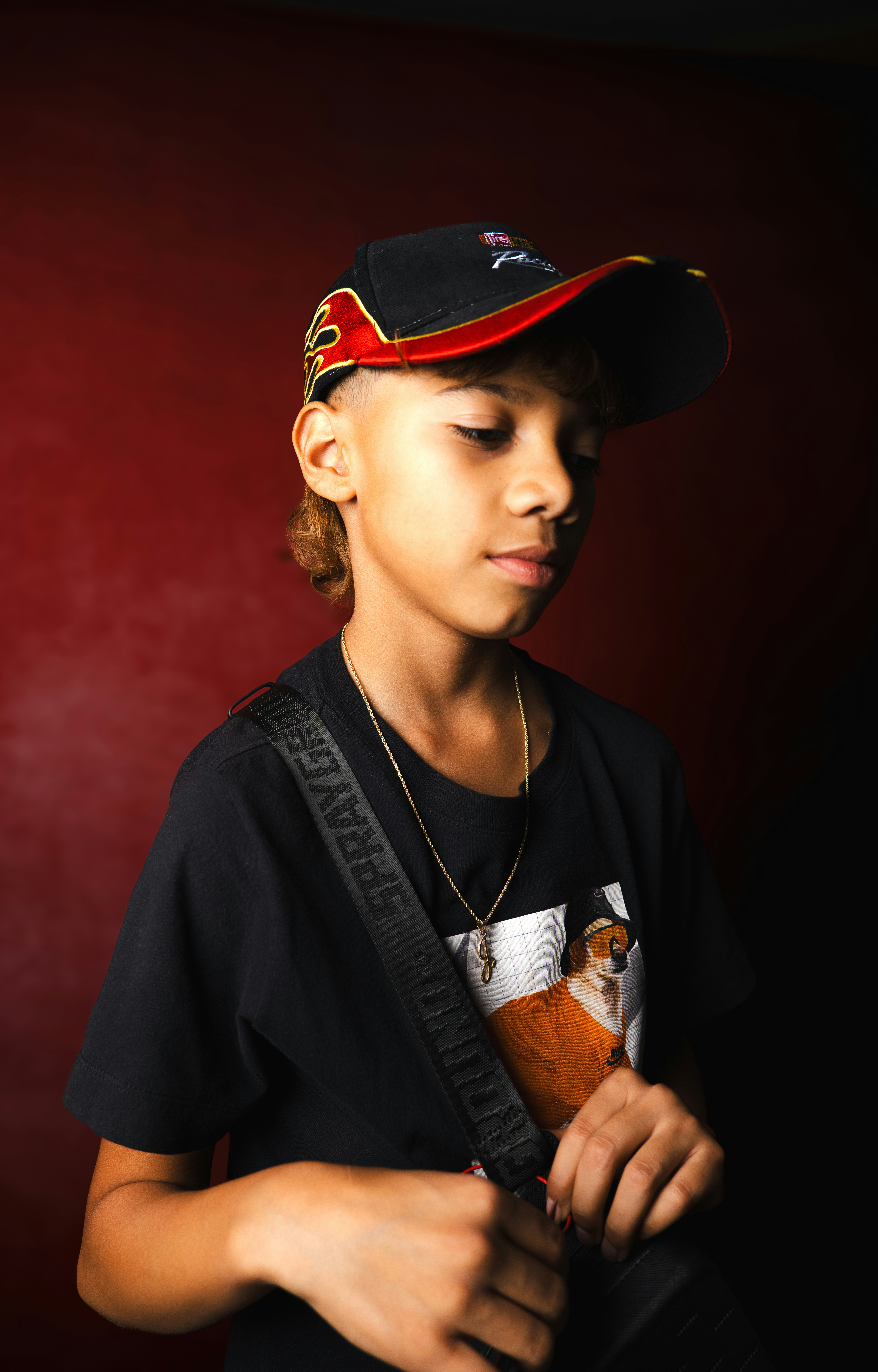 Cap and Confidence: A Portrait of Focused Youth in Red Hue