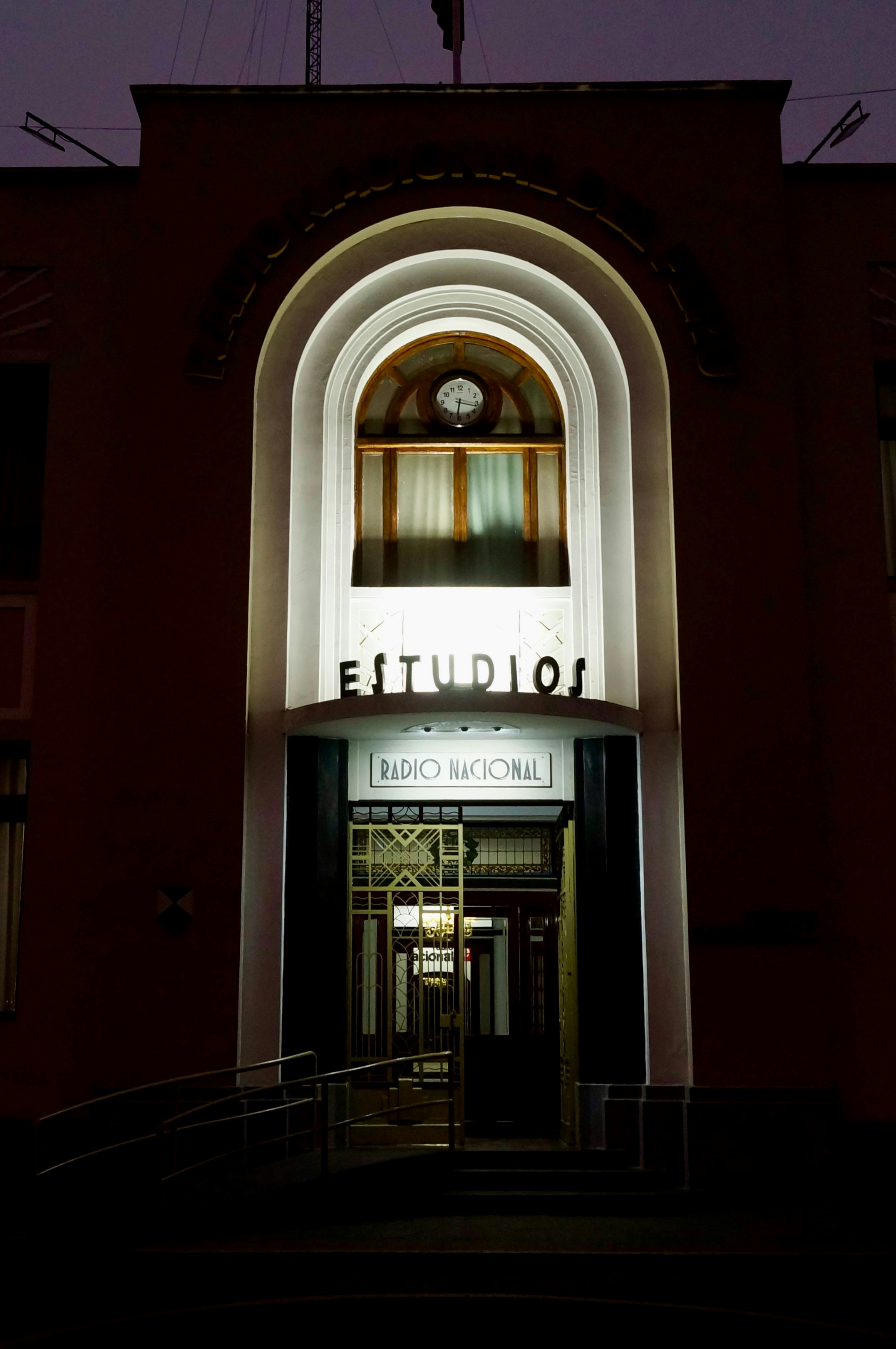 The Archway of Broadcast: A Neon-Soft Facade Awash in Dusk Light