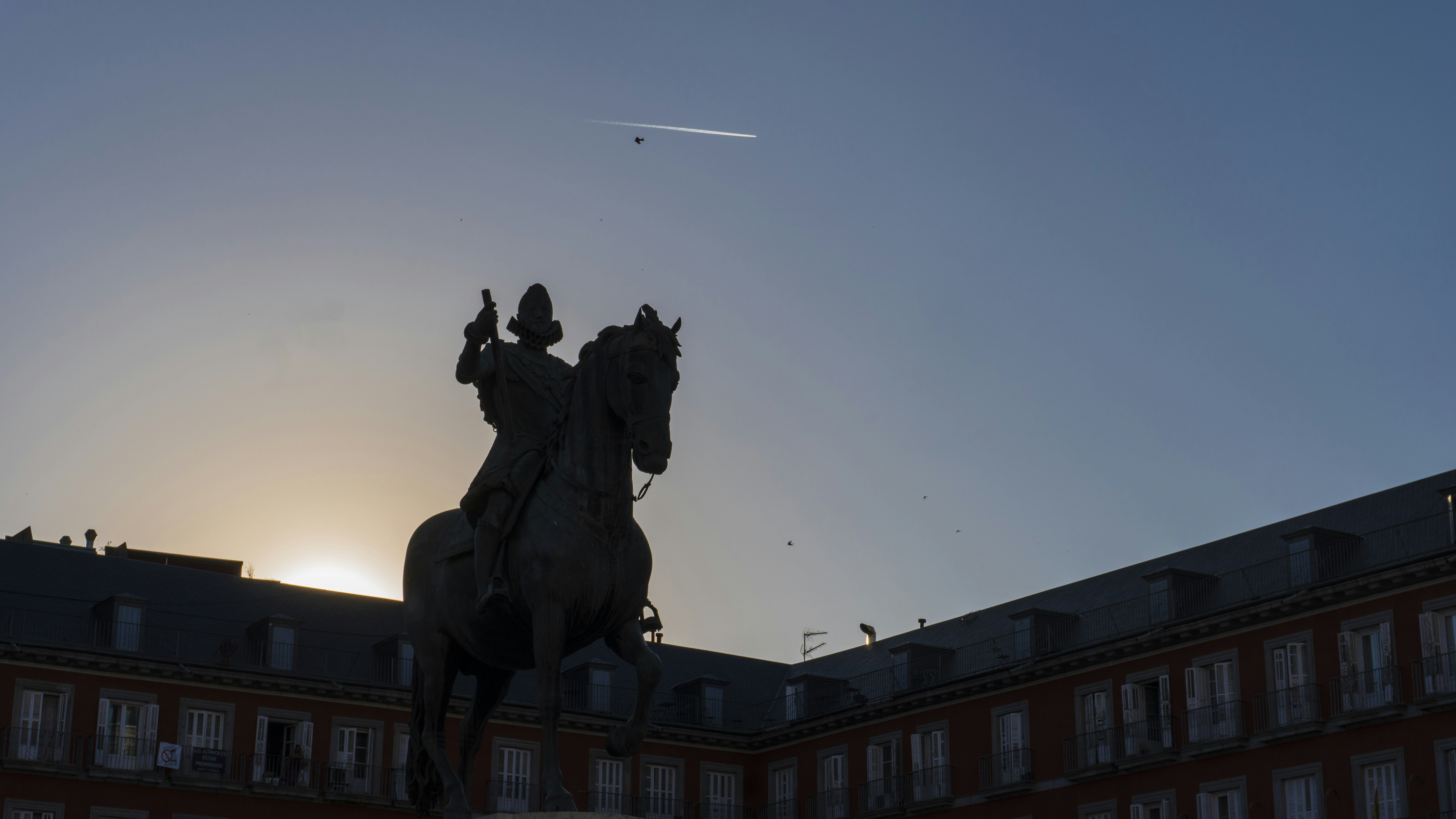 Rising Silhouette: A Horse and Rider Backlit by a Sunrise