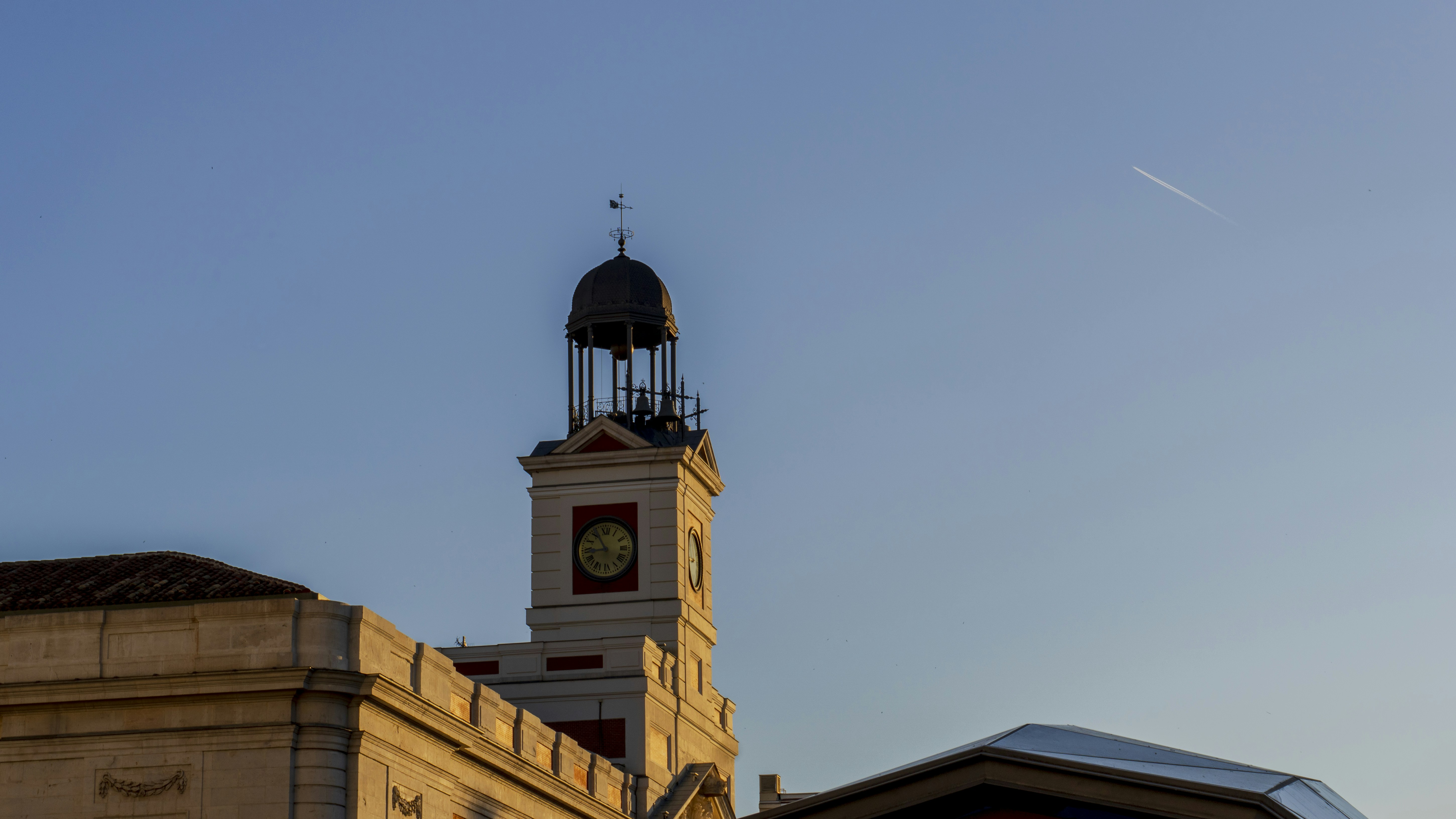 Clock Tower Amid a Quiet Skyline at Golden Hour