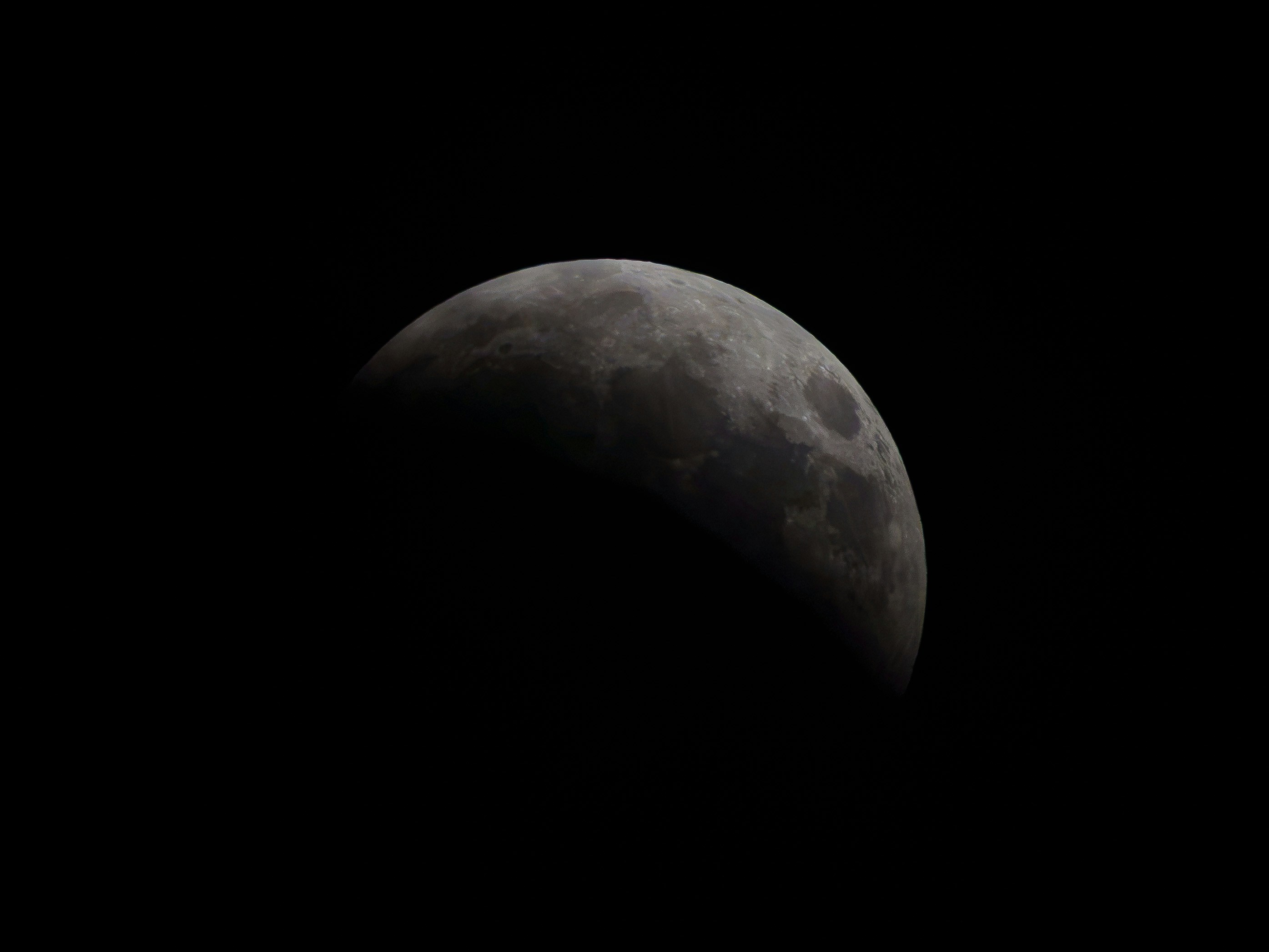 Partial Moon Emerges from Darkness