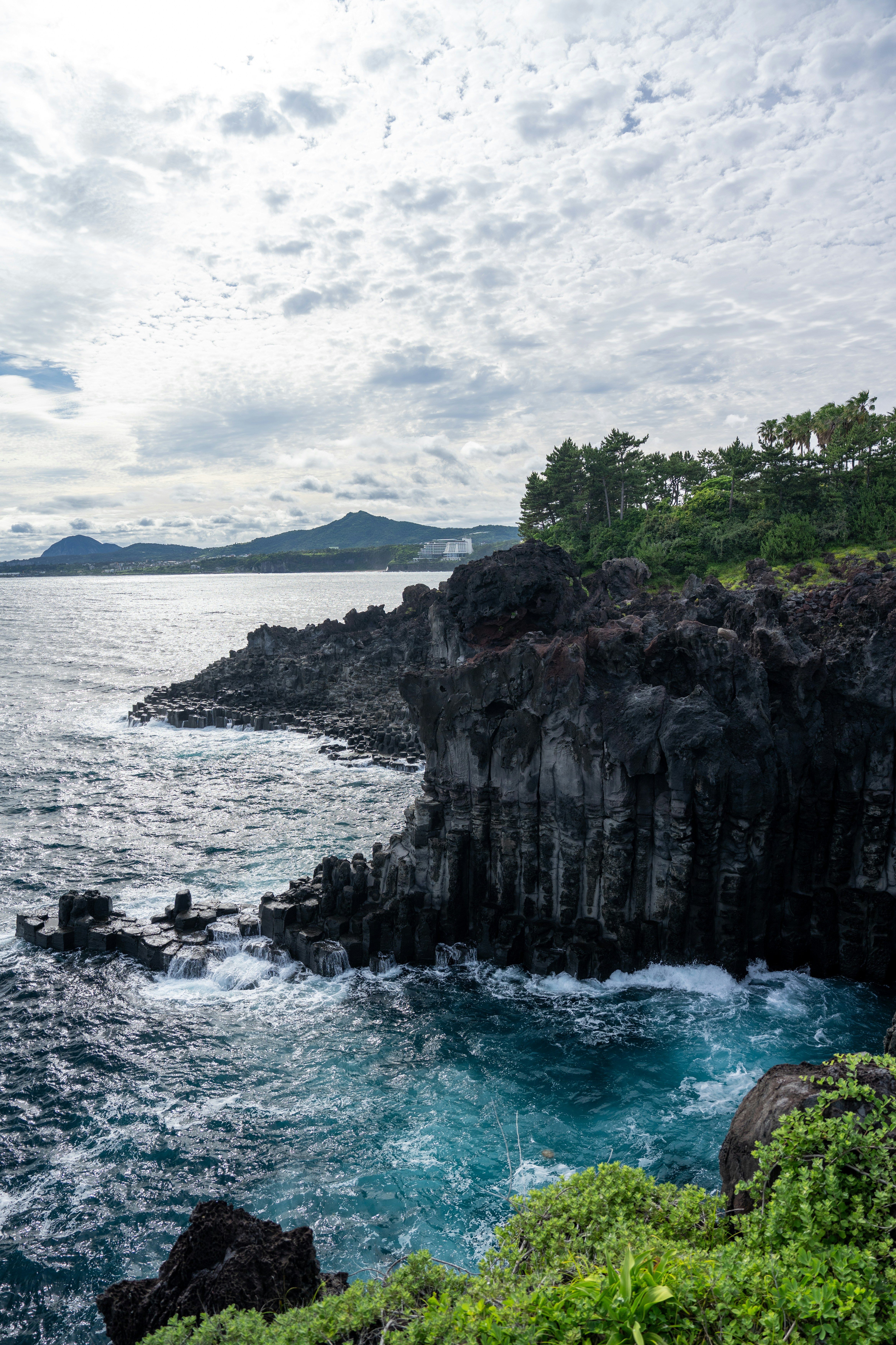 Lava-hew cliffs and turquoise sea along a coastal edge