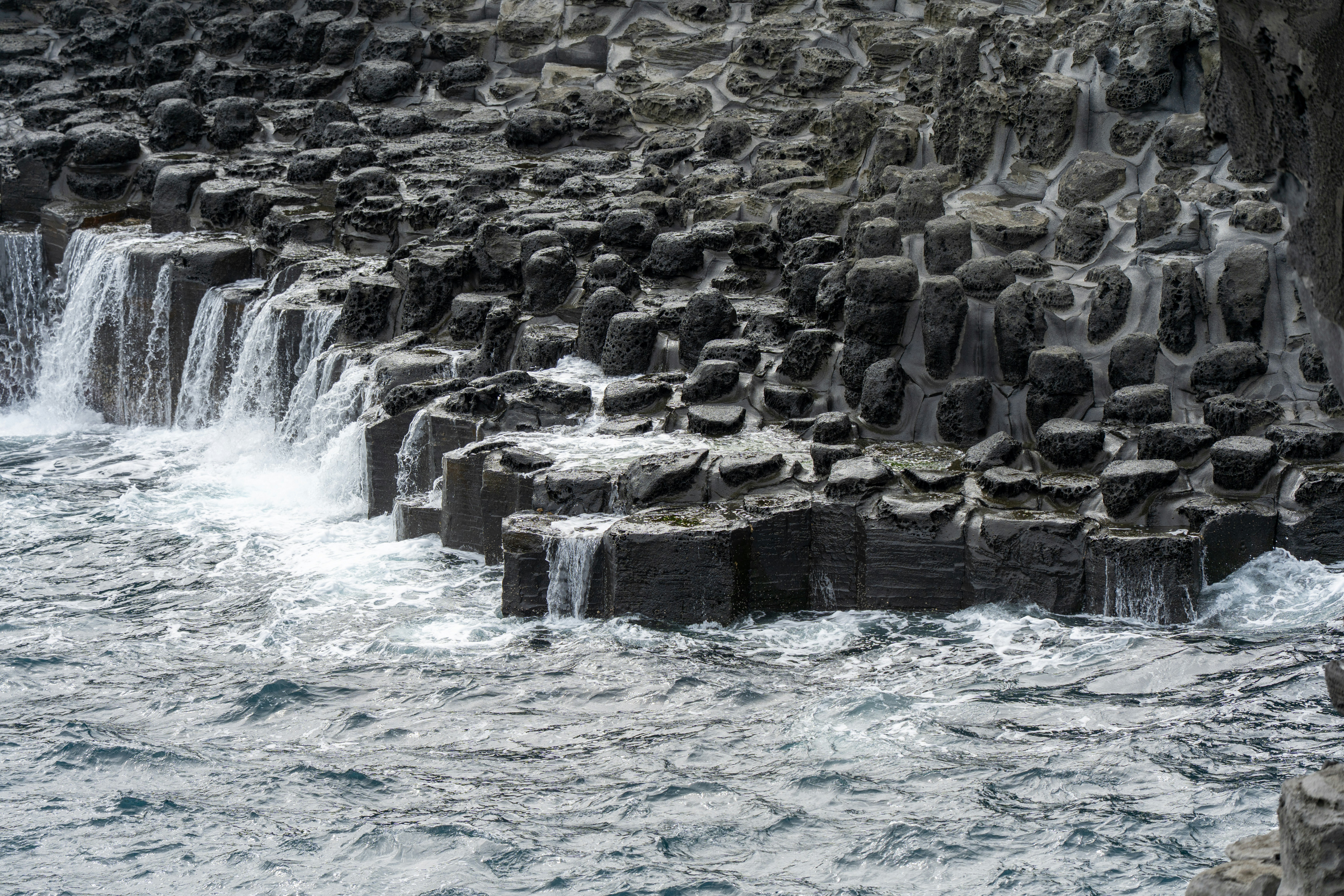 Stone Steps into the Sea: A Tidal Wall of Basalt and Foam