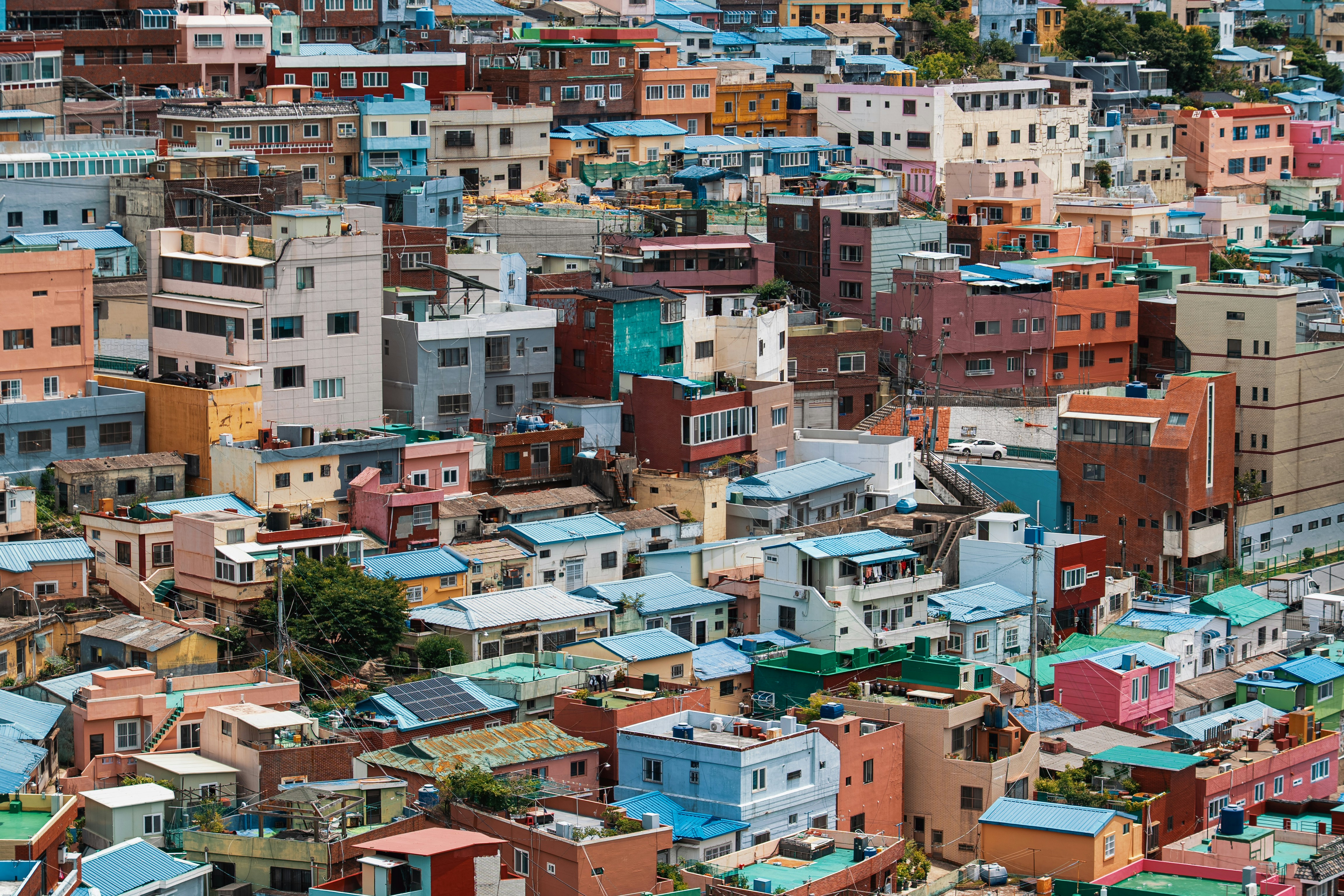 Colorful hillside grid: a sea of compact houses stacked in a sunlit village