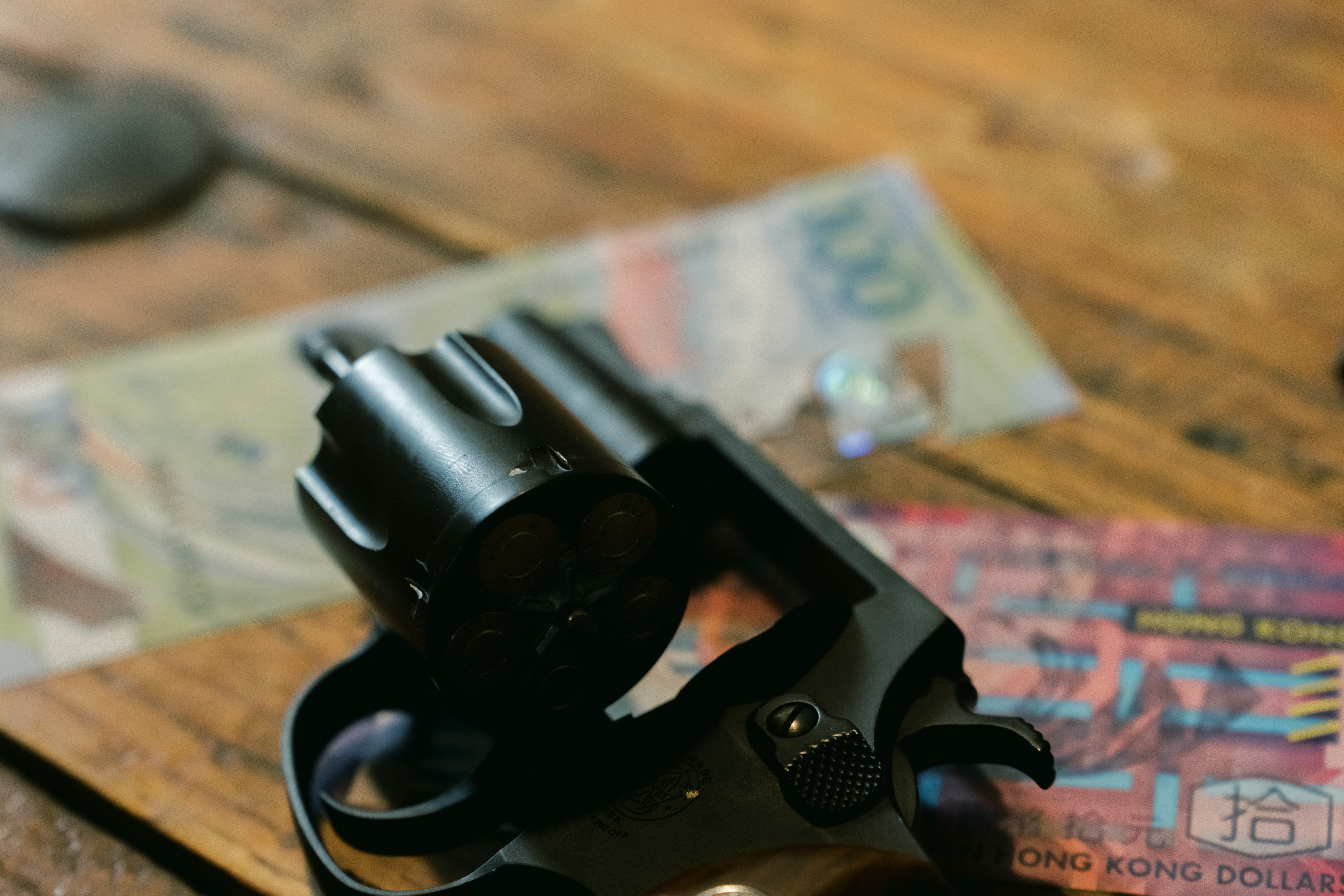 County of Curiosity: A Pocket Revolver Resting on a Wooden Counter