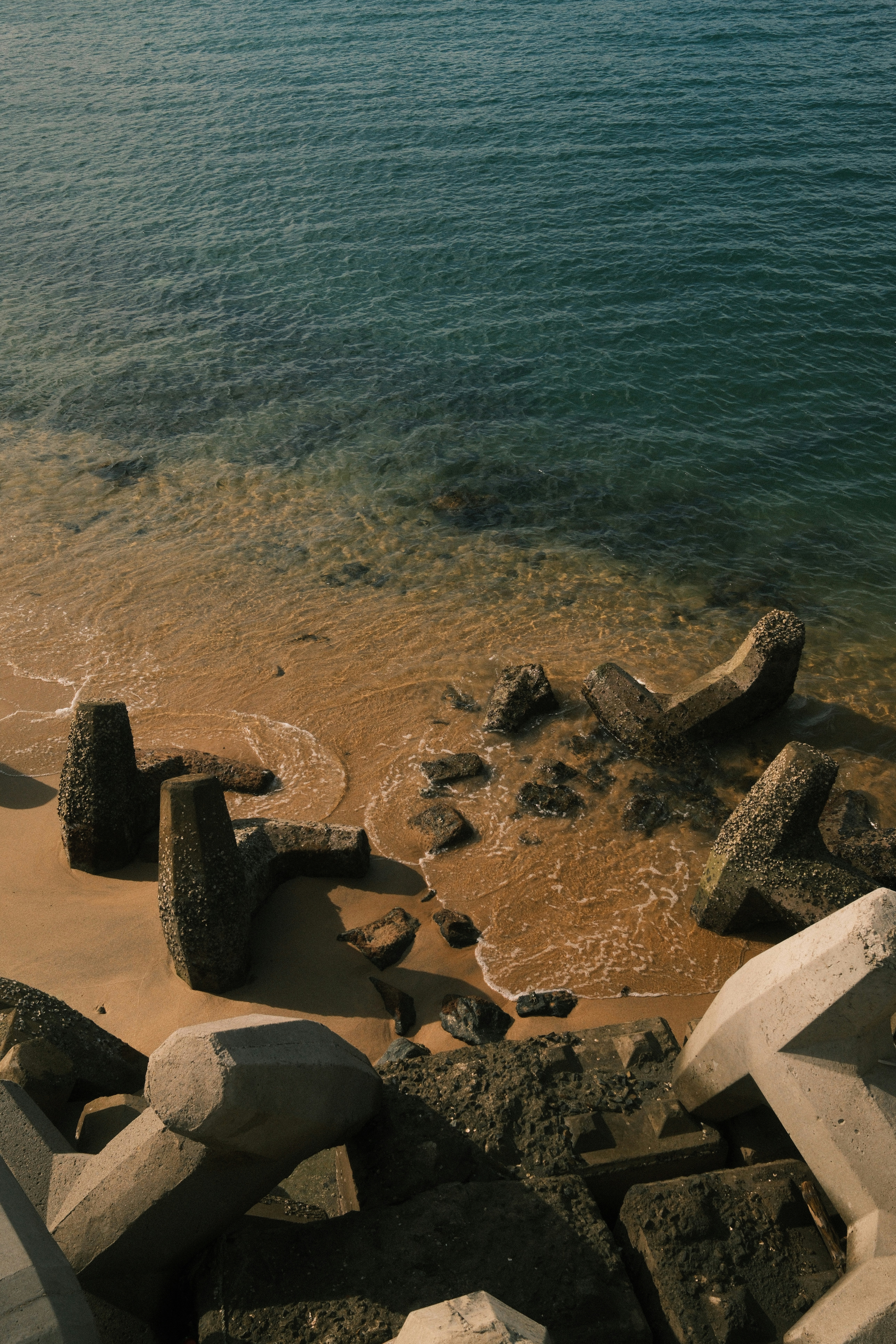 Pier-Roofed Shadowed Breakwaters Meet Shoreline Sunset