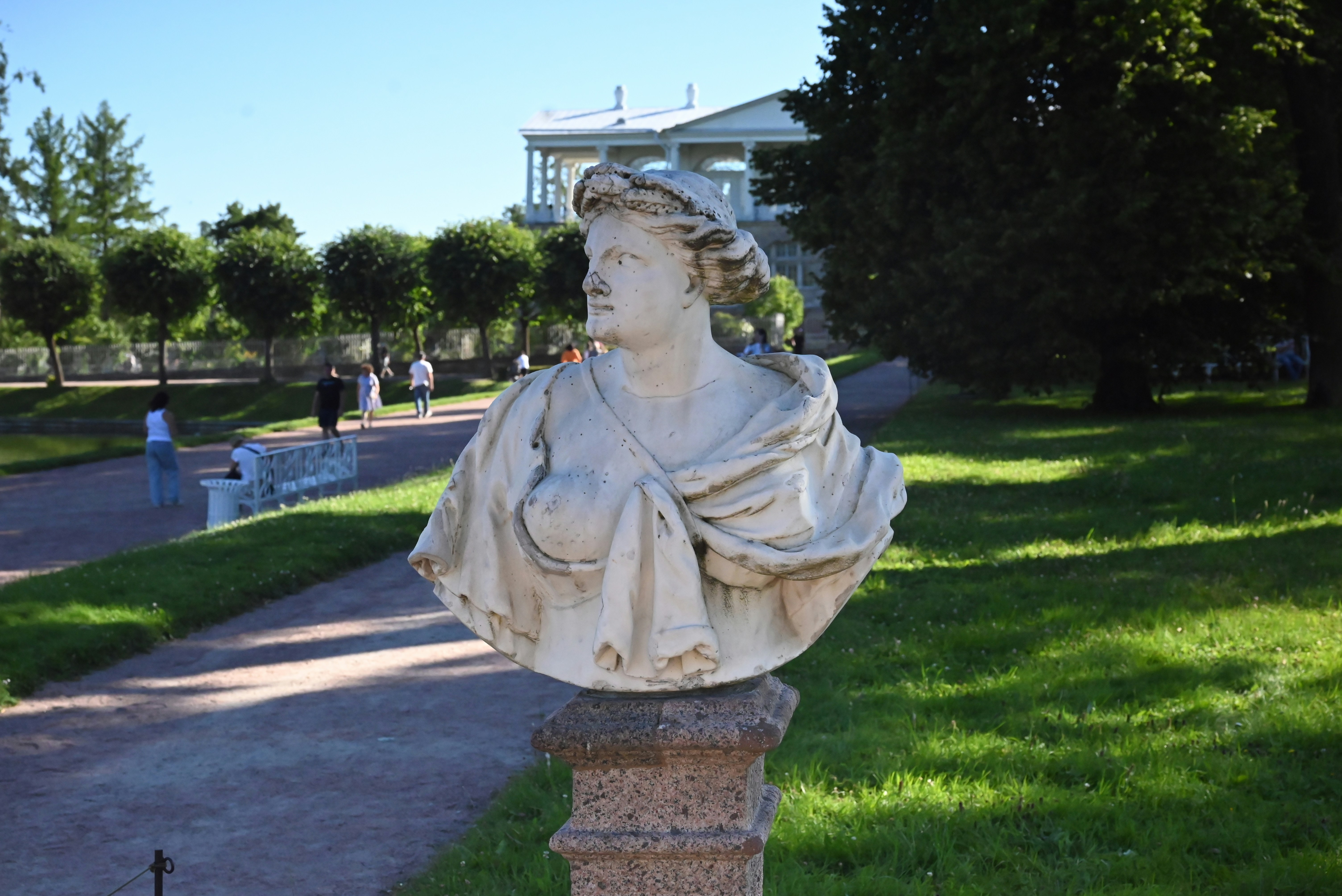 Marble Muse Among Sunlit Pathways