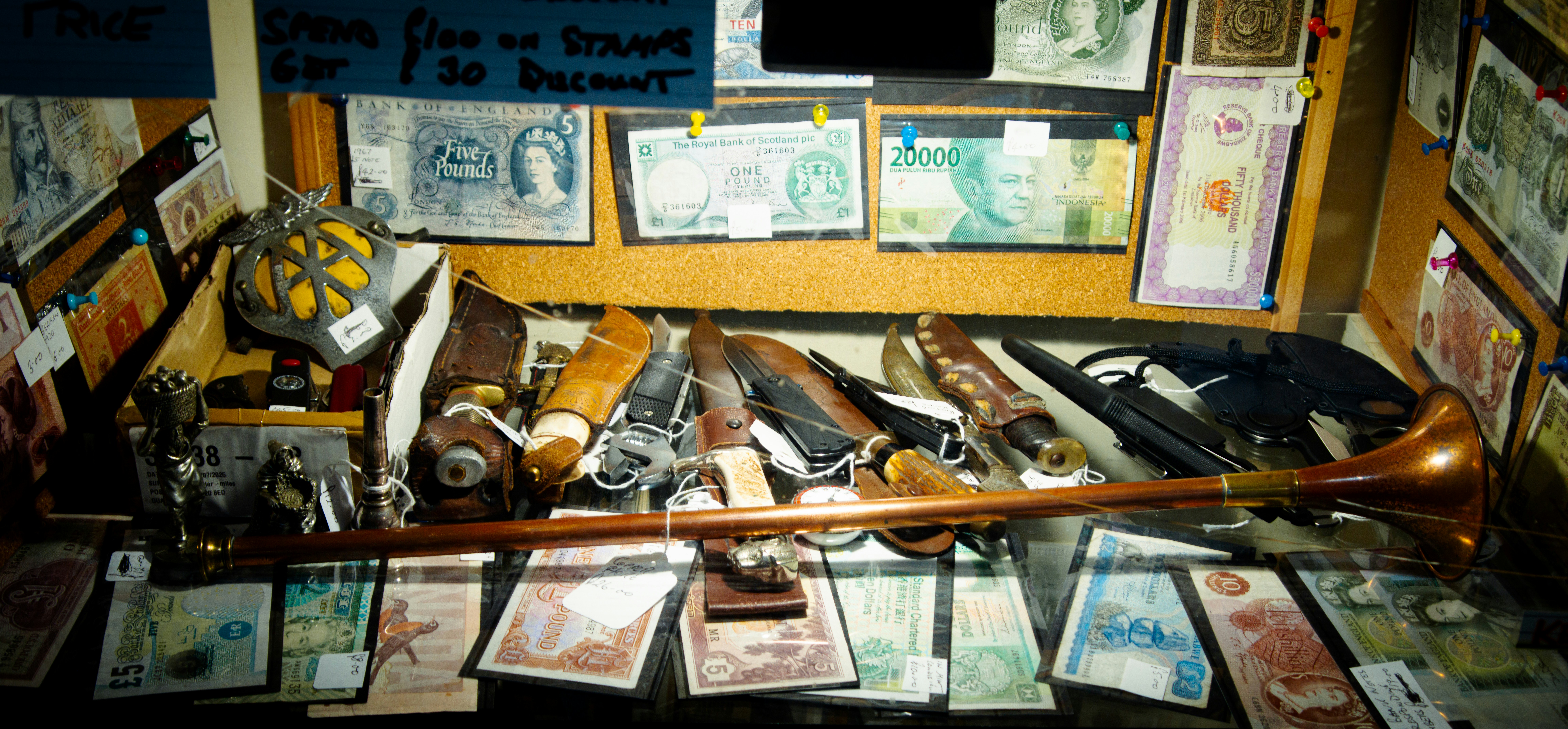 Arsenal of Cash: A Quiet Display of Firearms and Worn Wallets