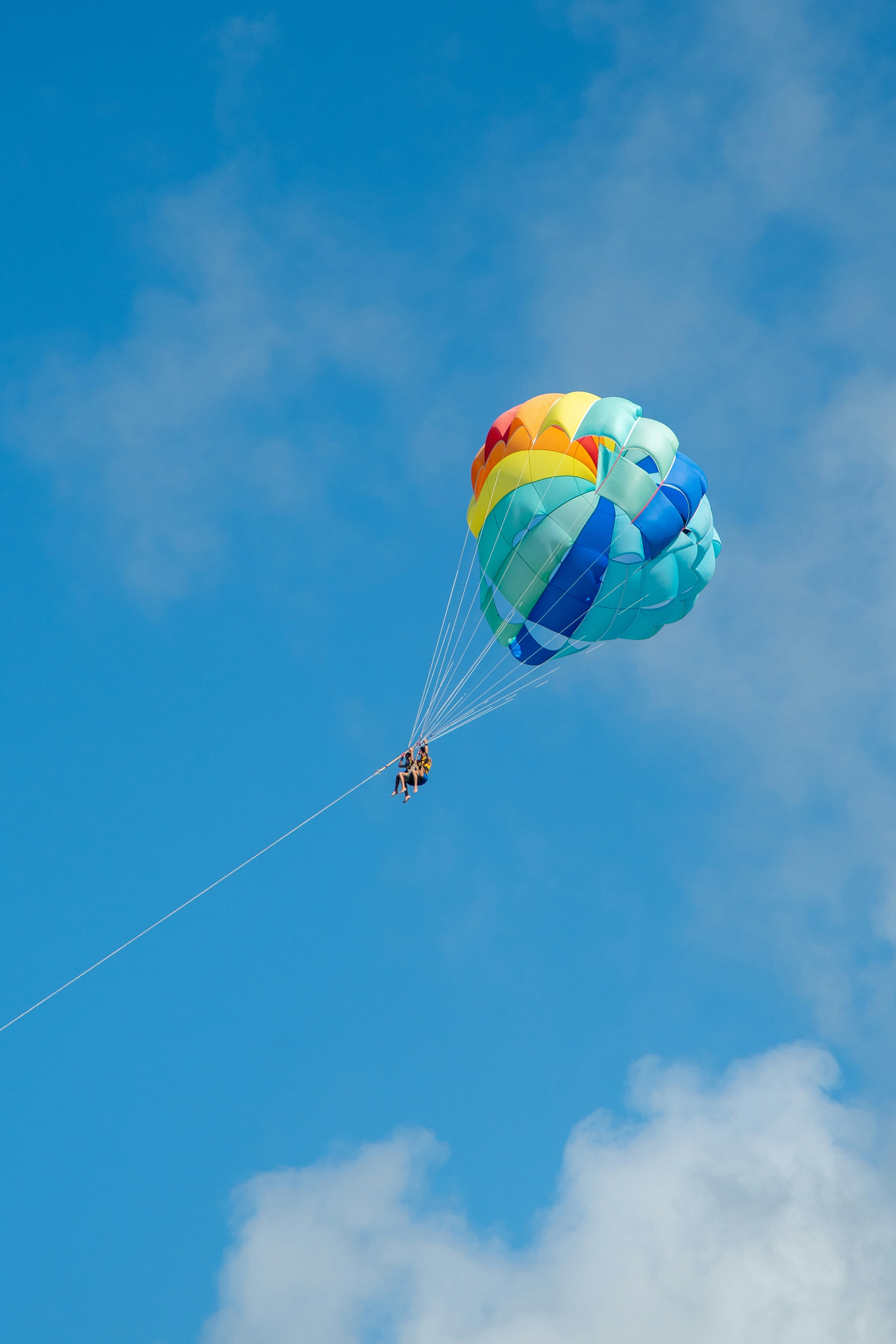 Rainbow Parasail: Flight over a Bright Blue Sky