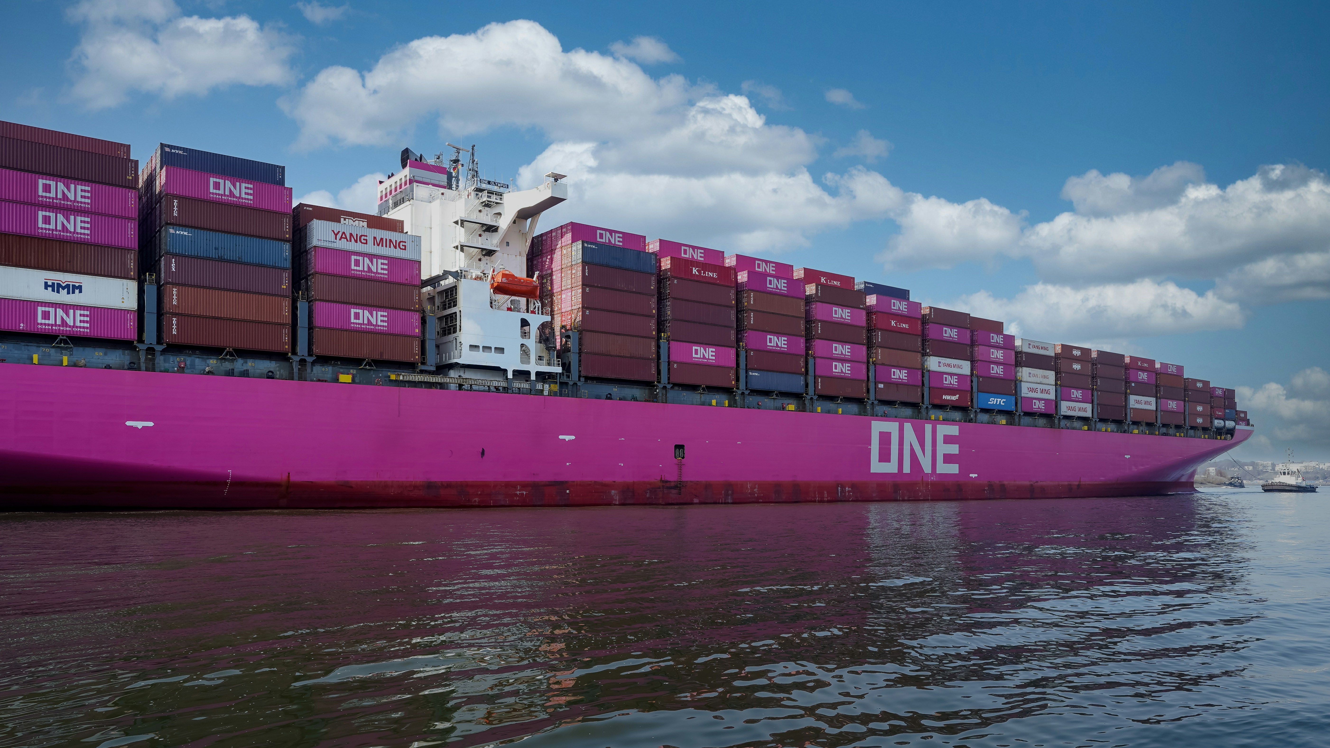 Pink Horizon: A Container Vessel Under a Bright Sky
