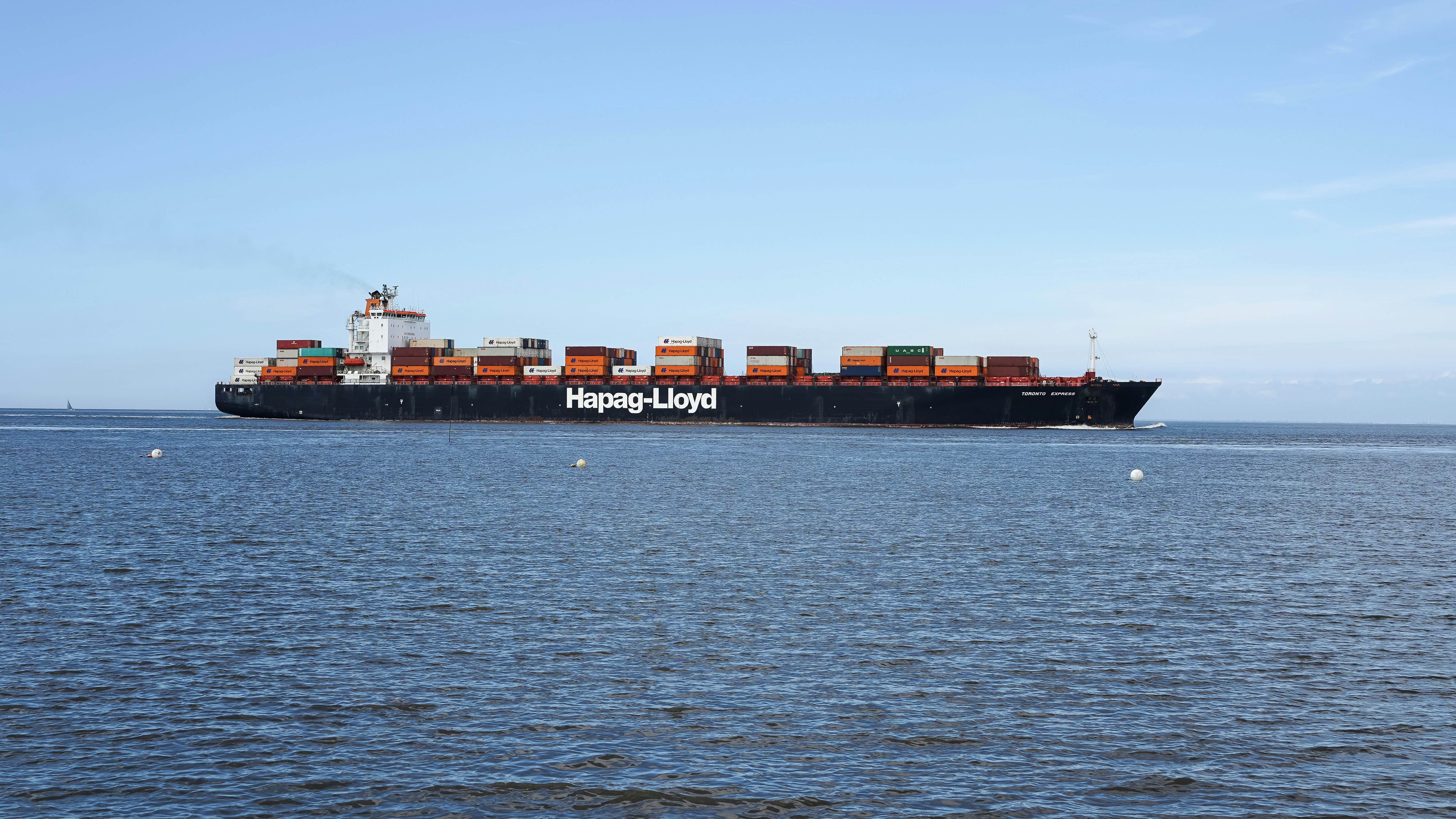 Horizon-hauling Freight: A Lined Vessel Across Calm Waters
