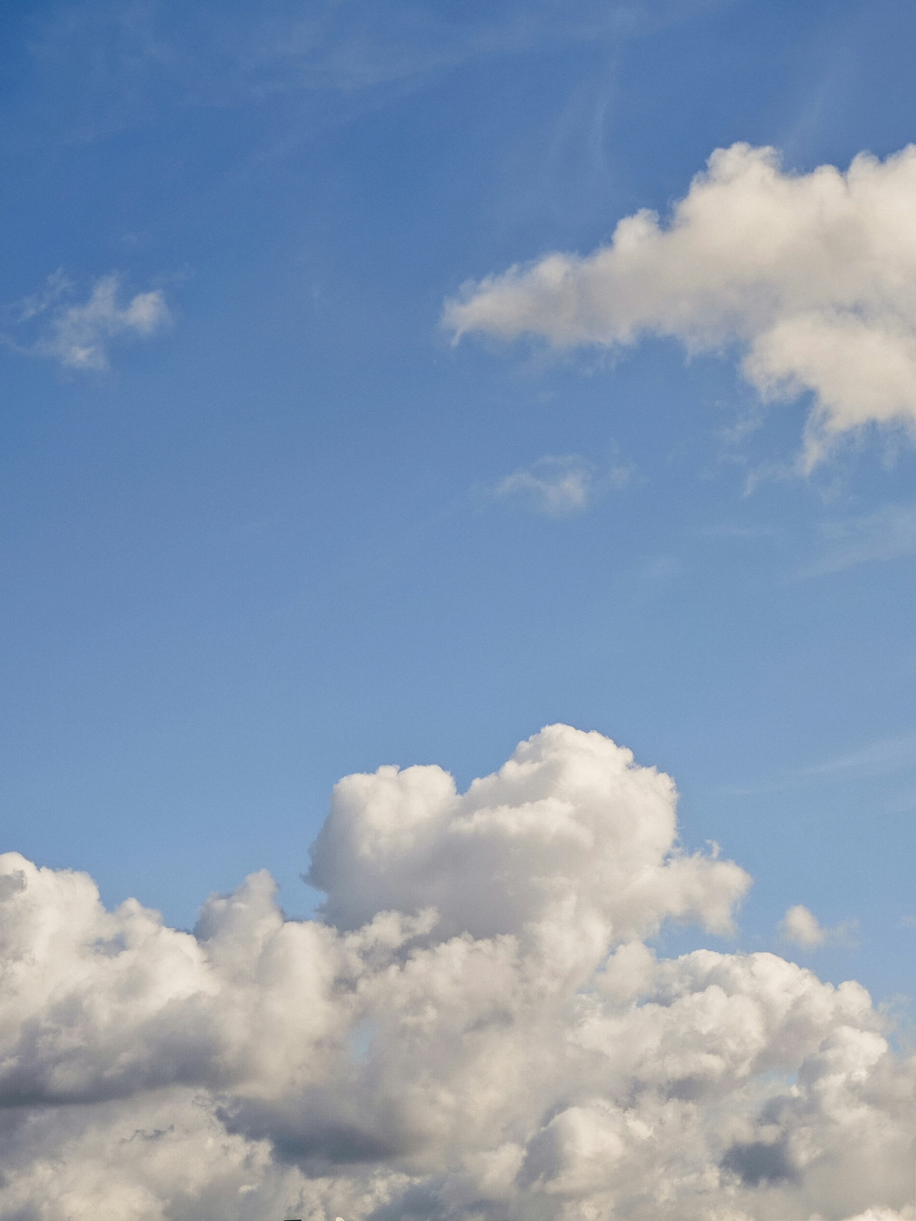 Blue Sky and Puffed Clouds Beyond a Quiet Horizon