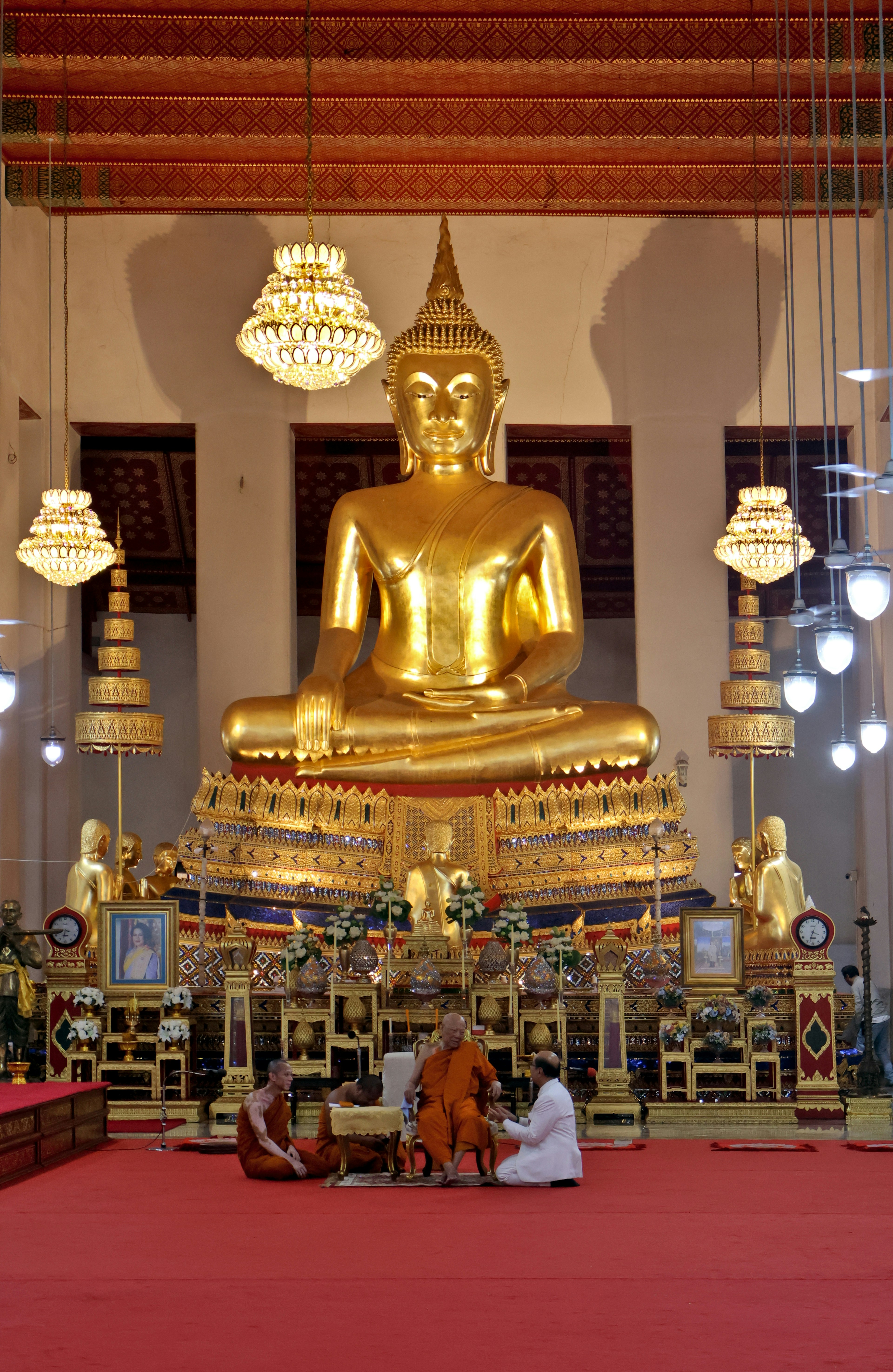 Golden Buddha Shrine: Monks in Reverent Circle Under Amber Light
