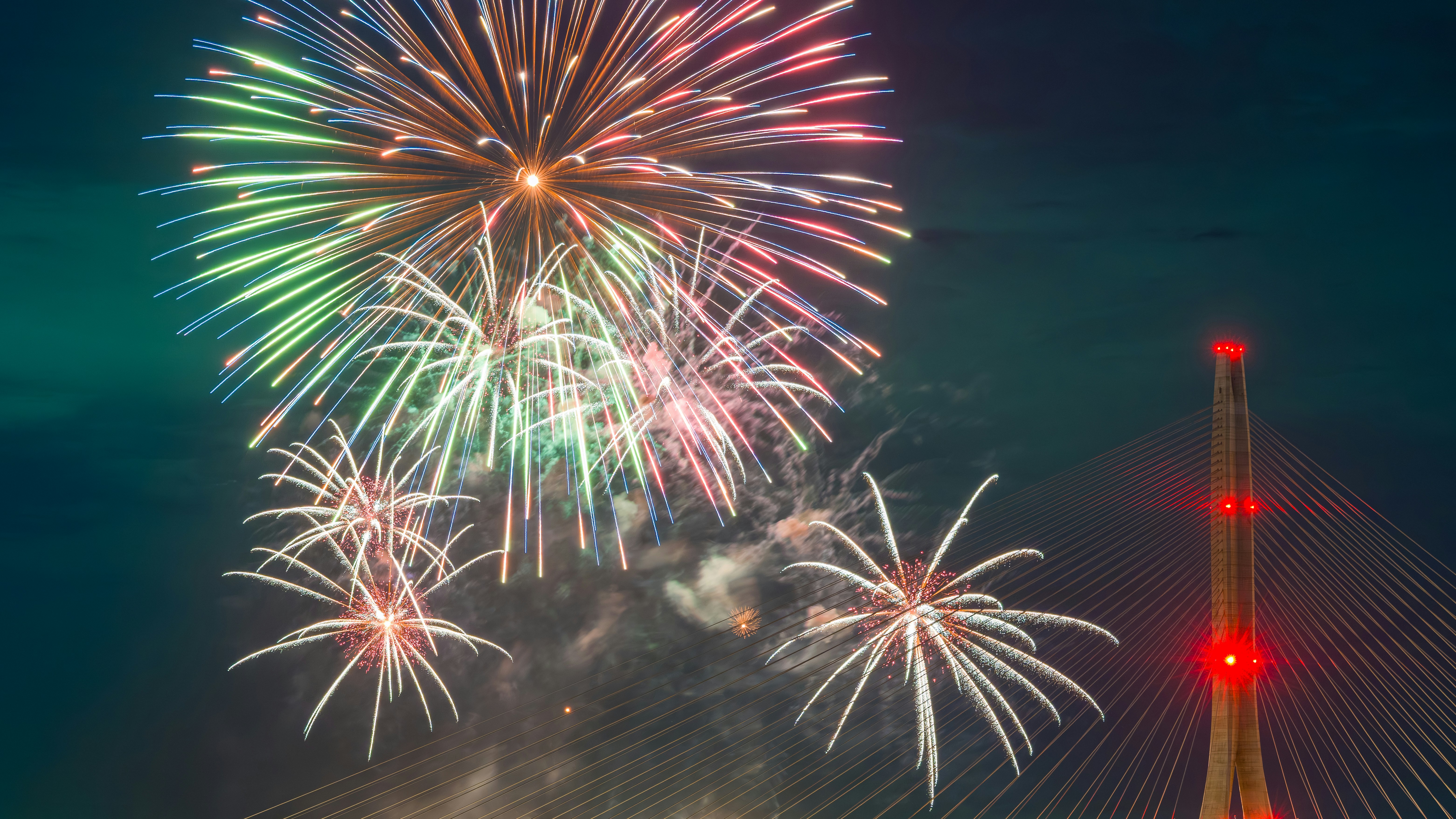 Night Sky Orchestration: Fireworks Over a Modern Bridge