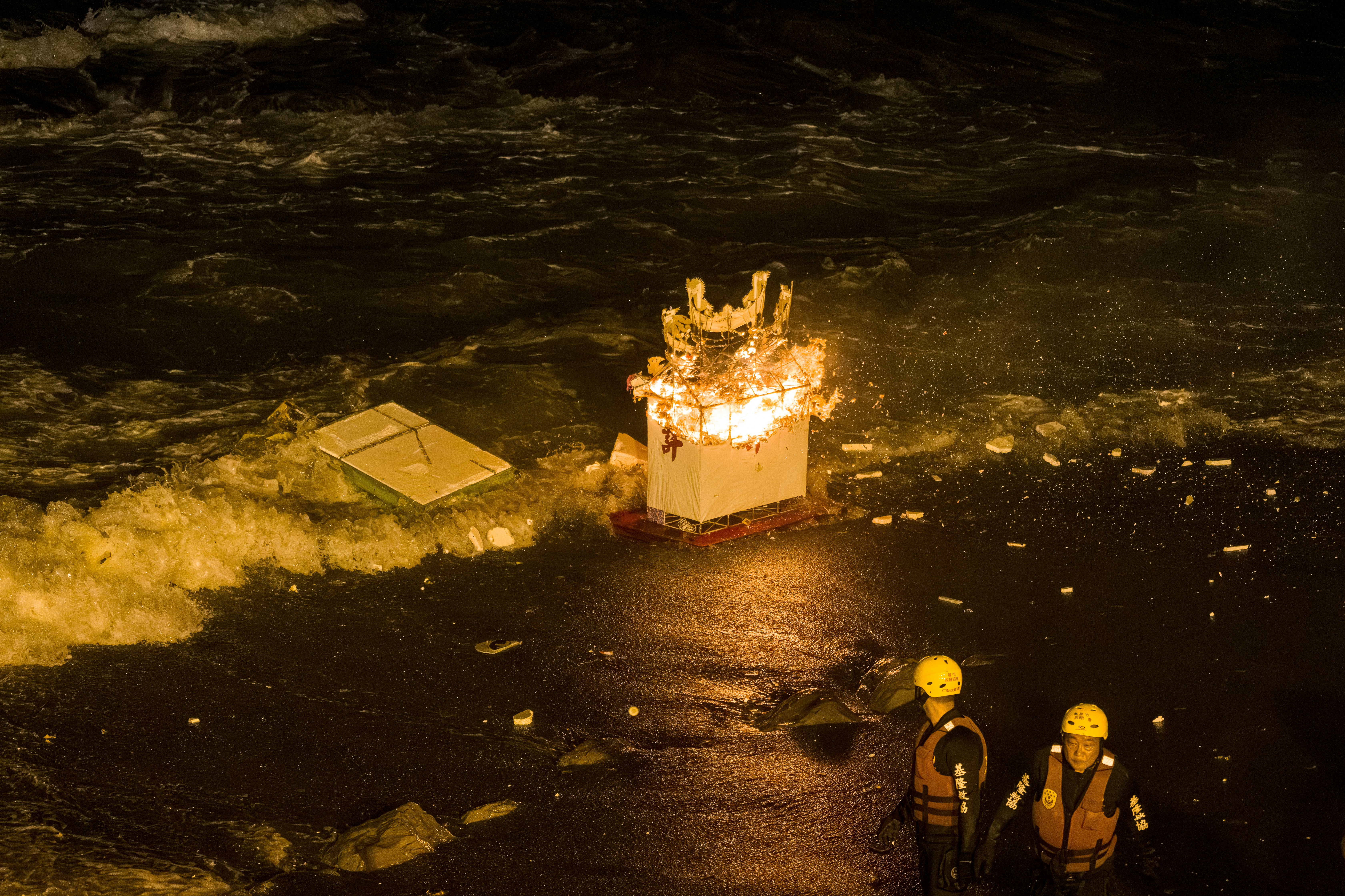 Flames at the Ferry: A Nighttime Rescue Scene by the Water
