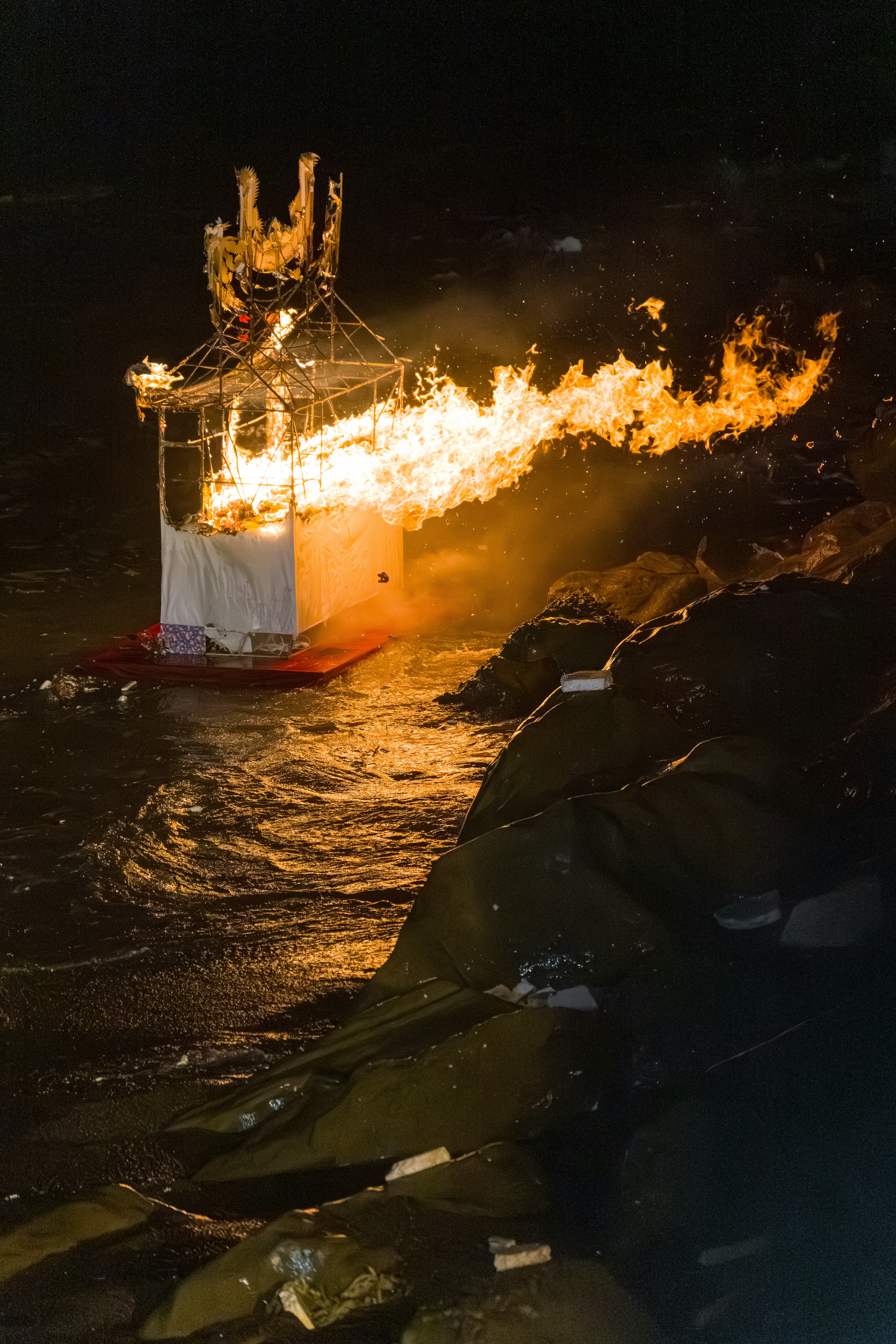 Inferno on the Pier: A Flaming Catamaran Illuminates Night Tide