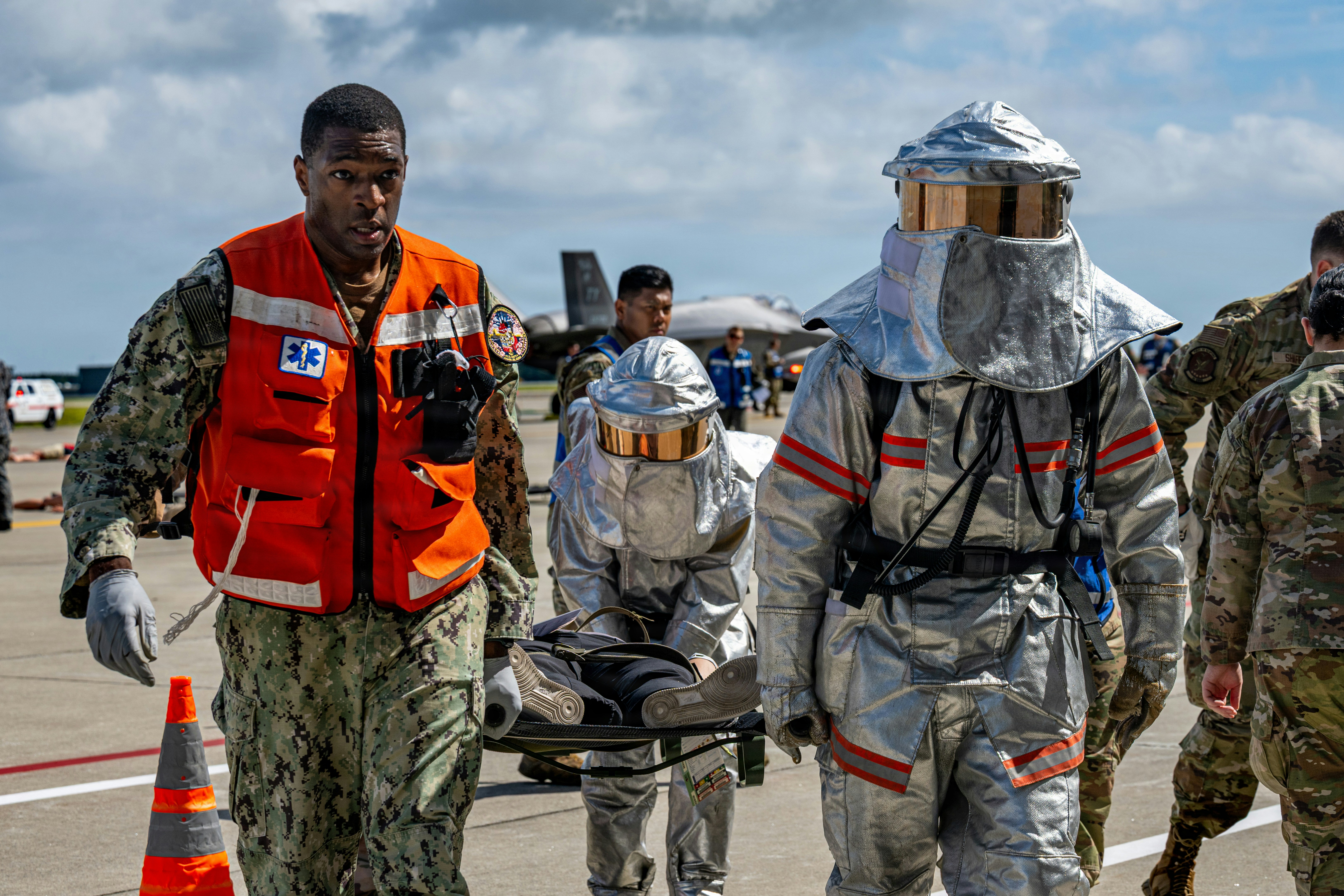 First Responders Move a Wounded Comrade on the Helipad