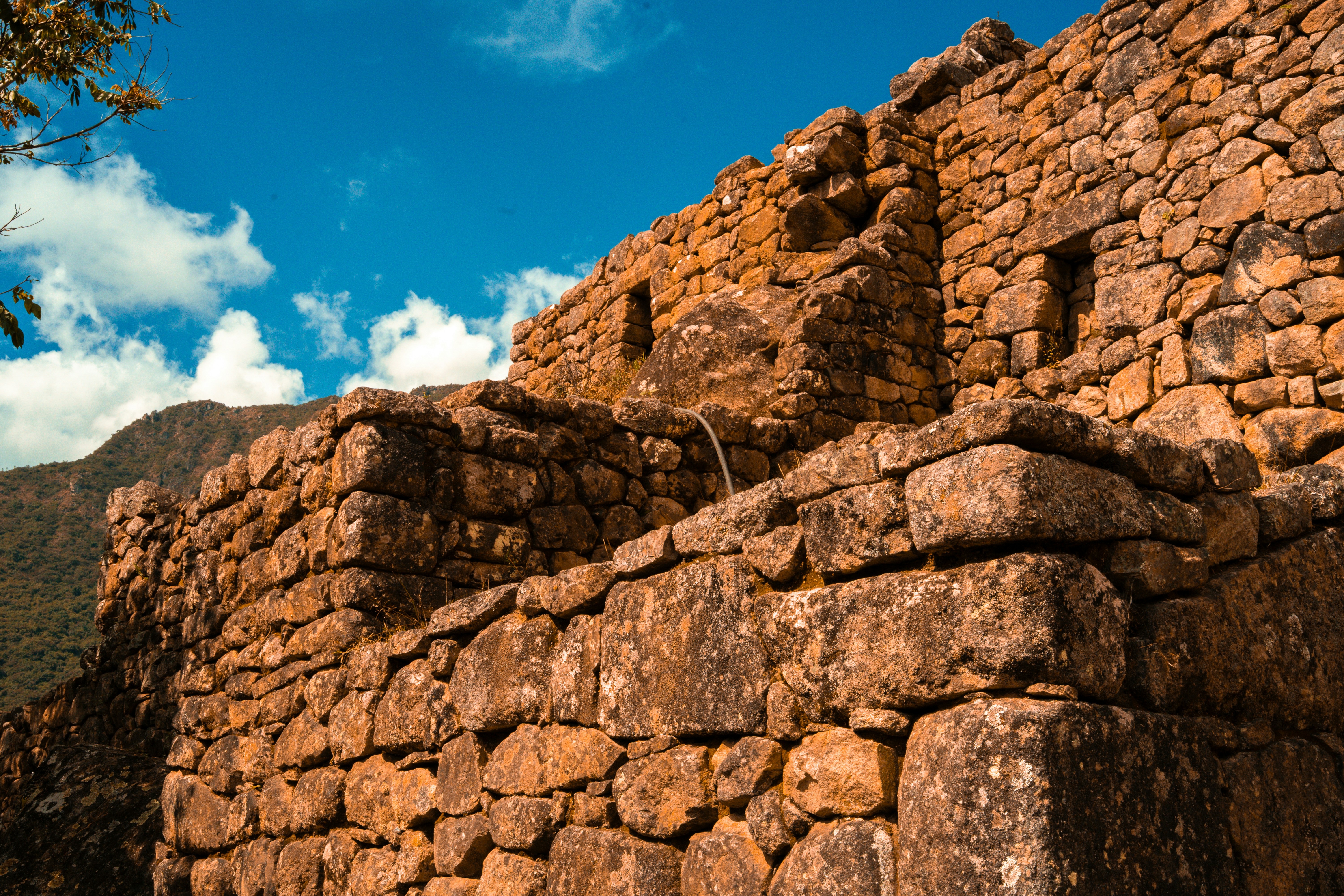 Ancient stone terraces under a bright Andean sky