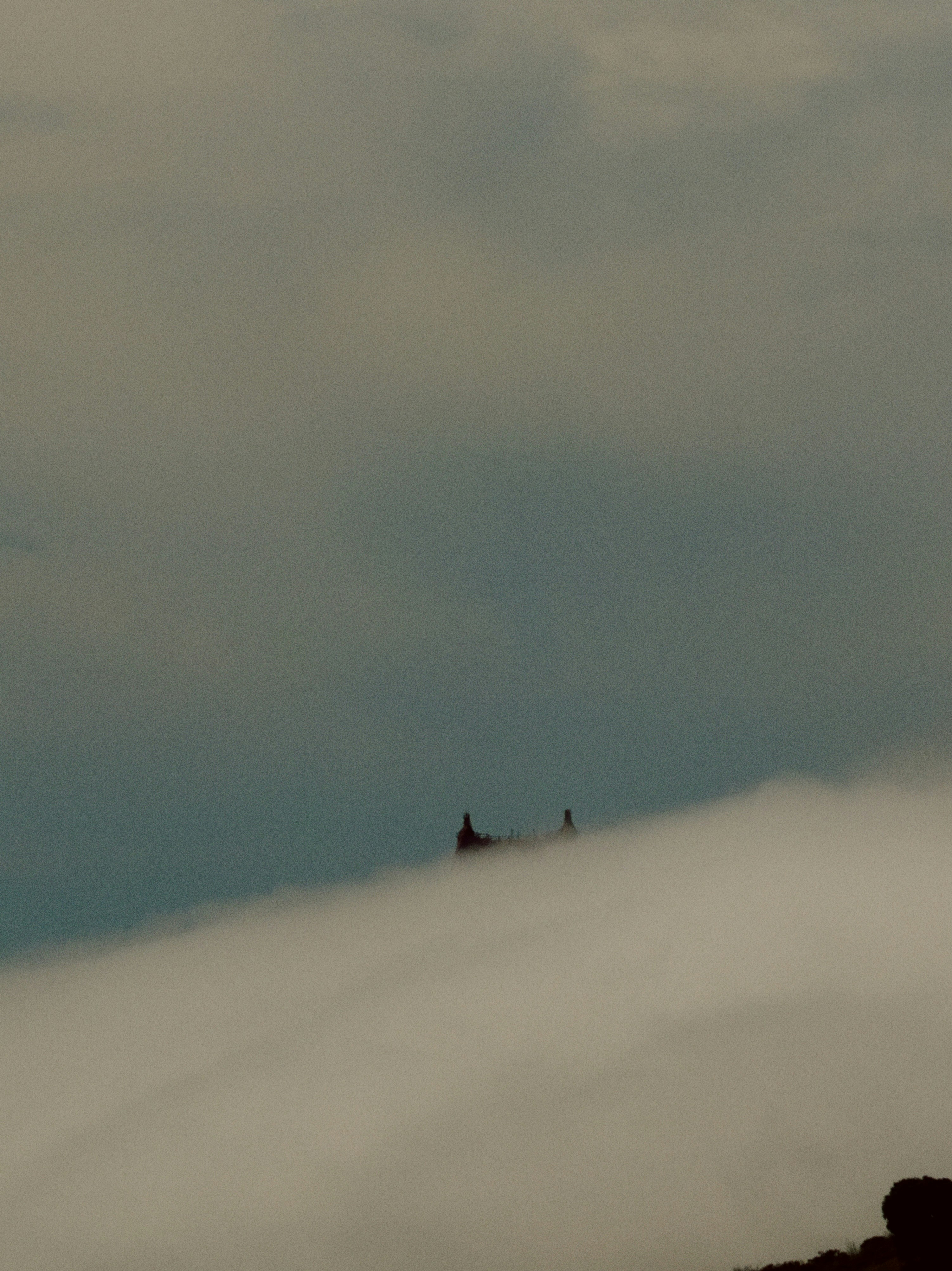 Peaks Above the Clouds: Two Terracotta Spires Peeking Through A Sea of Mist