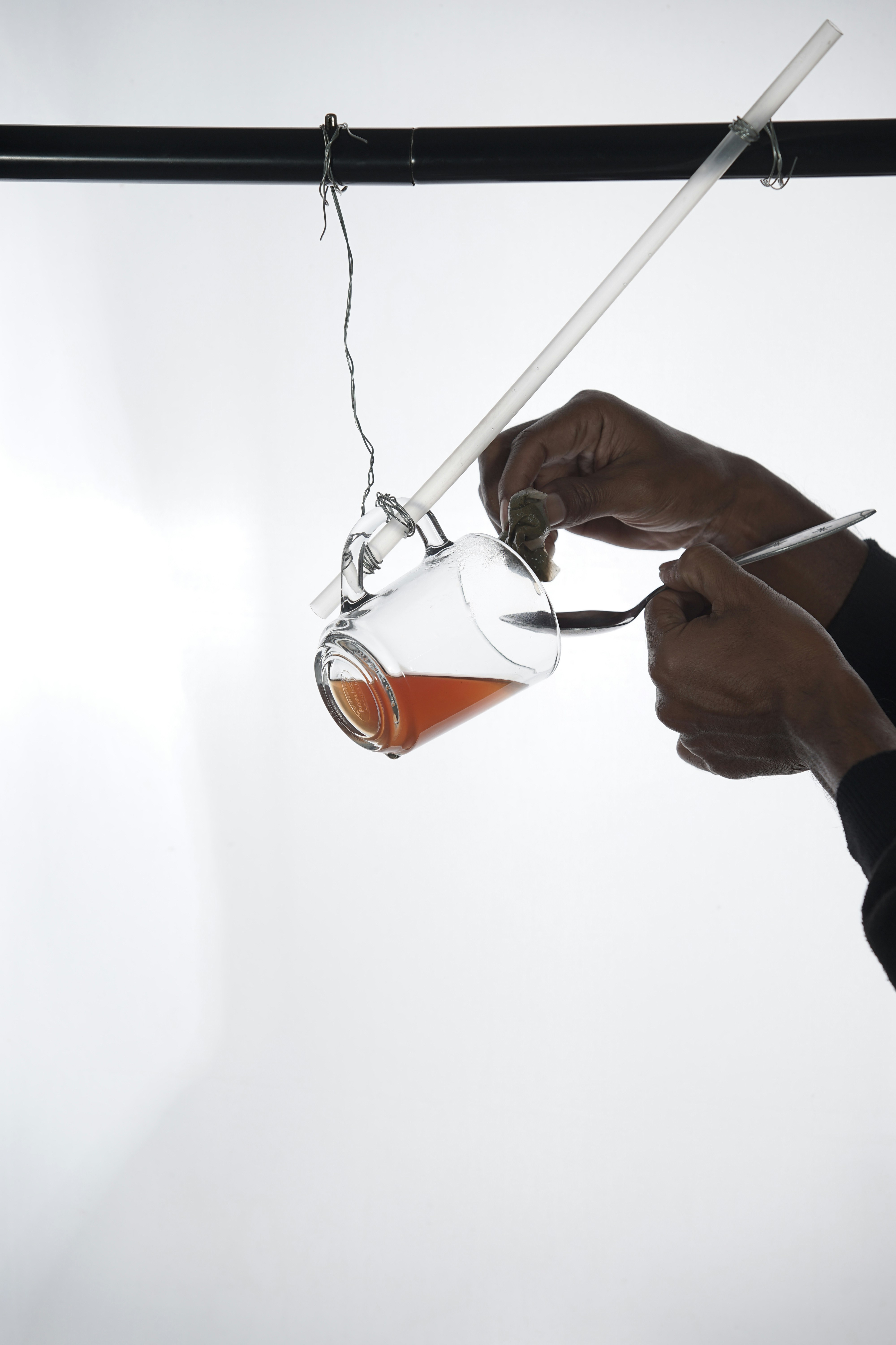 Suspended Cup and Handheld Precision in a Minimal Studio