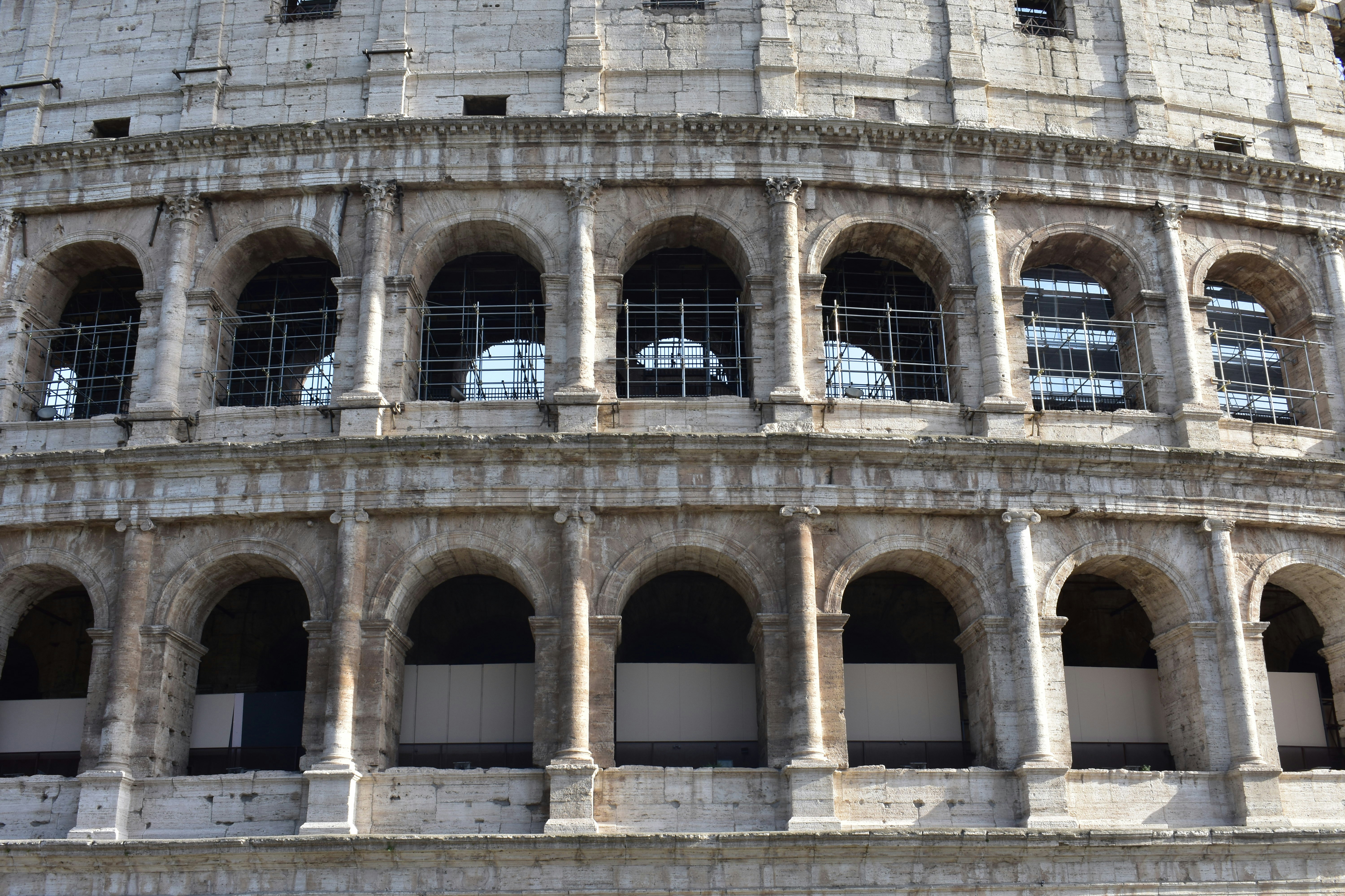 Stone Arches Reflected: The Weathered Facade of the Colosseum