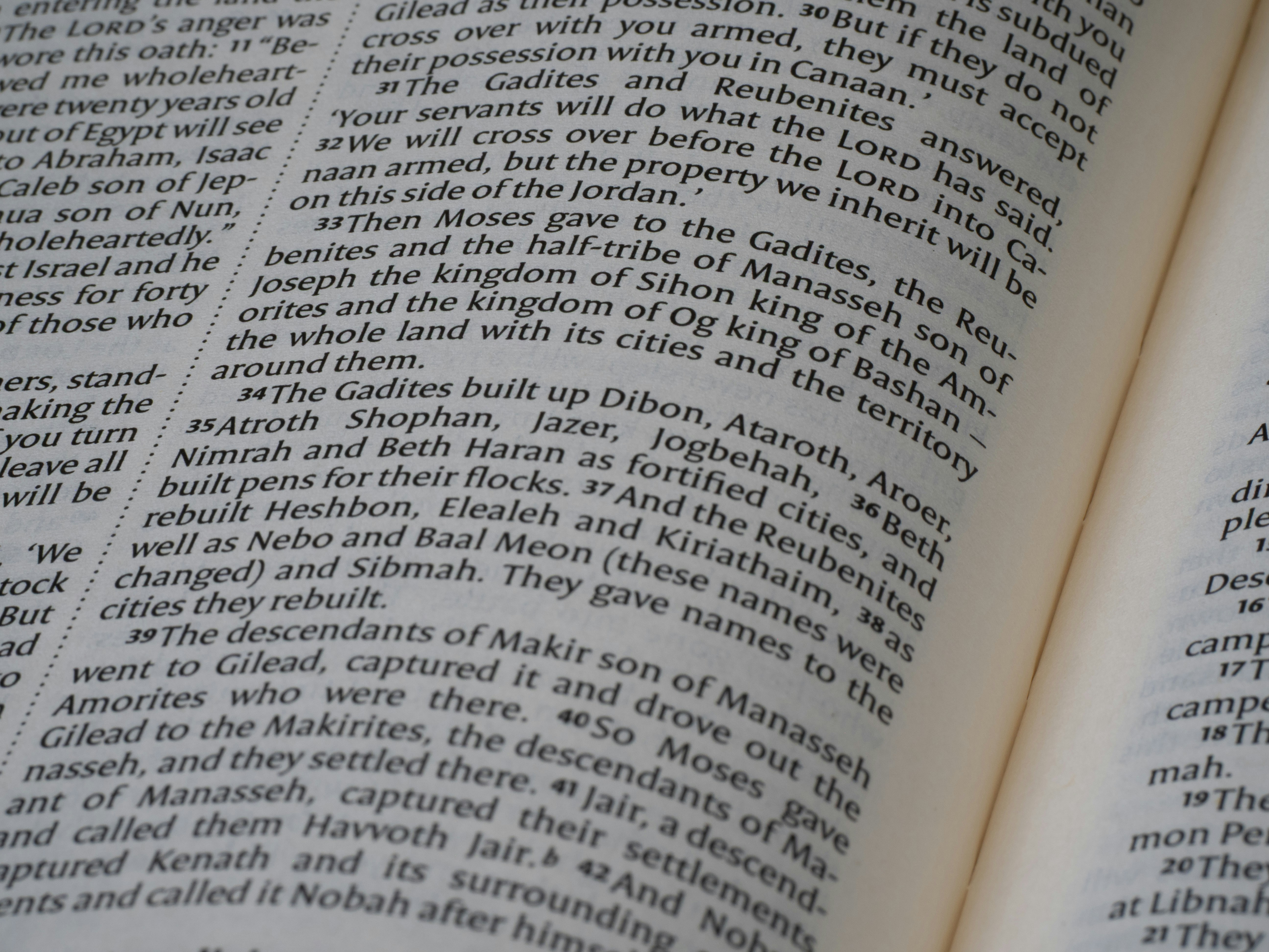 Close-up of densely printed book text with curved page margins; the photo emphasizes typography and the tactile page edges.