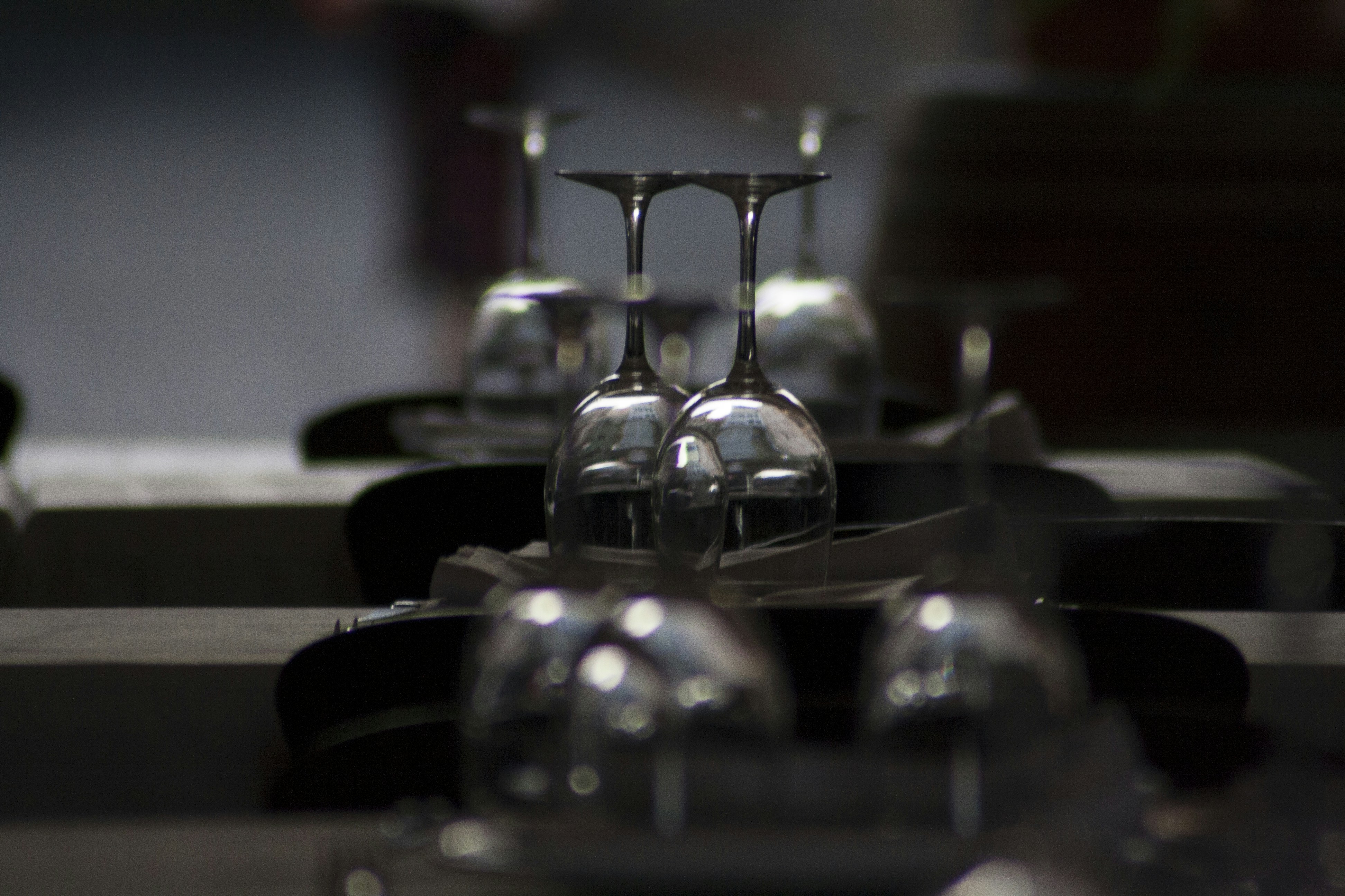Upside-Down Reflections: A Row of Glasses in a Quiet Bar
