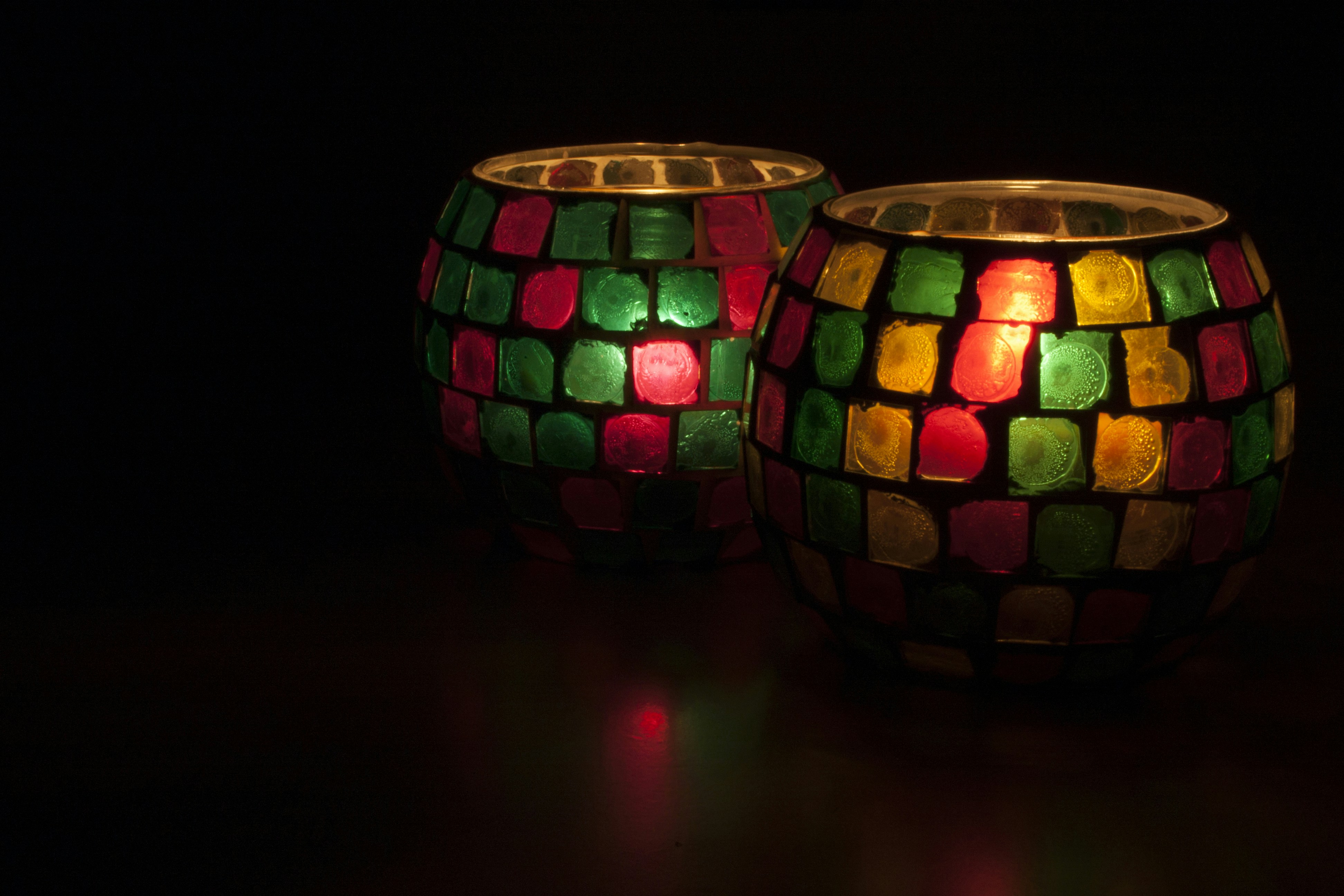 Dim Mosaic Glow: Twin Glass Vessels in Low Light