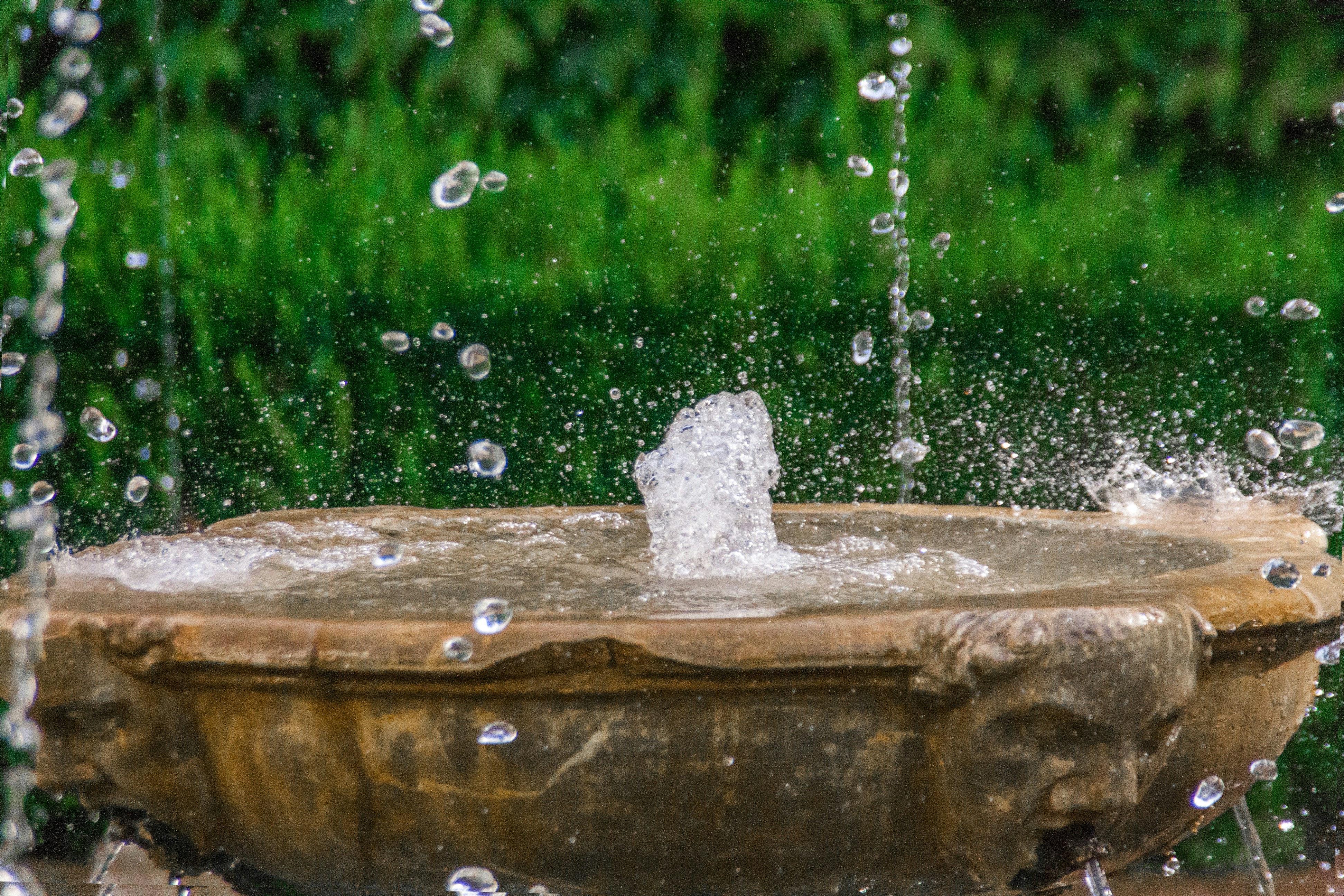 A Droplet Ballet on a Stone Fountain