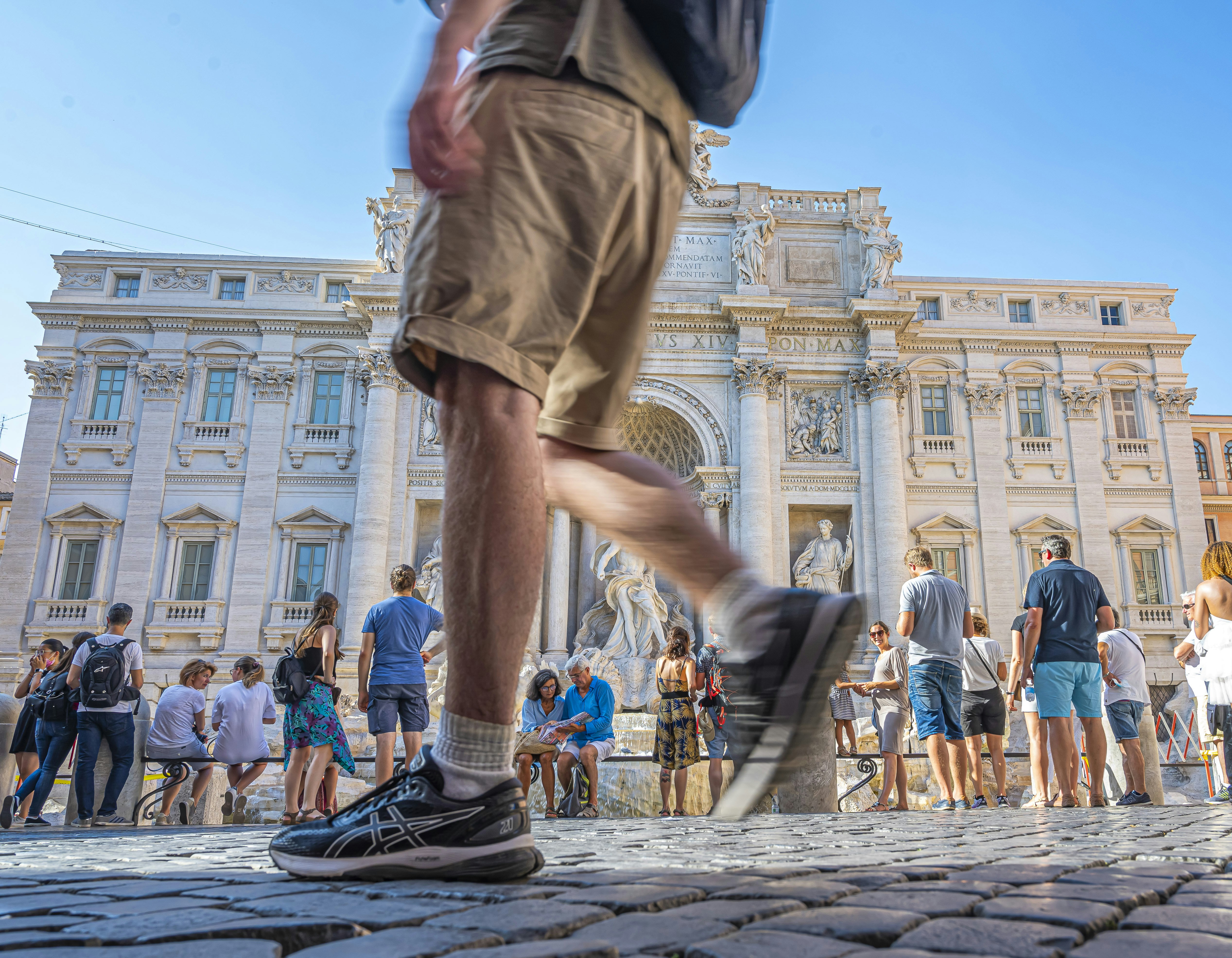 Footsteps Across the Fountain: A Traveler’s Moment in a Grand Square