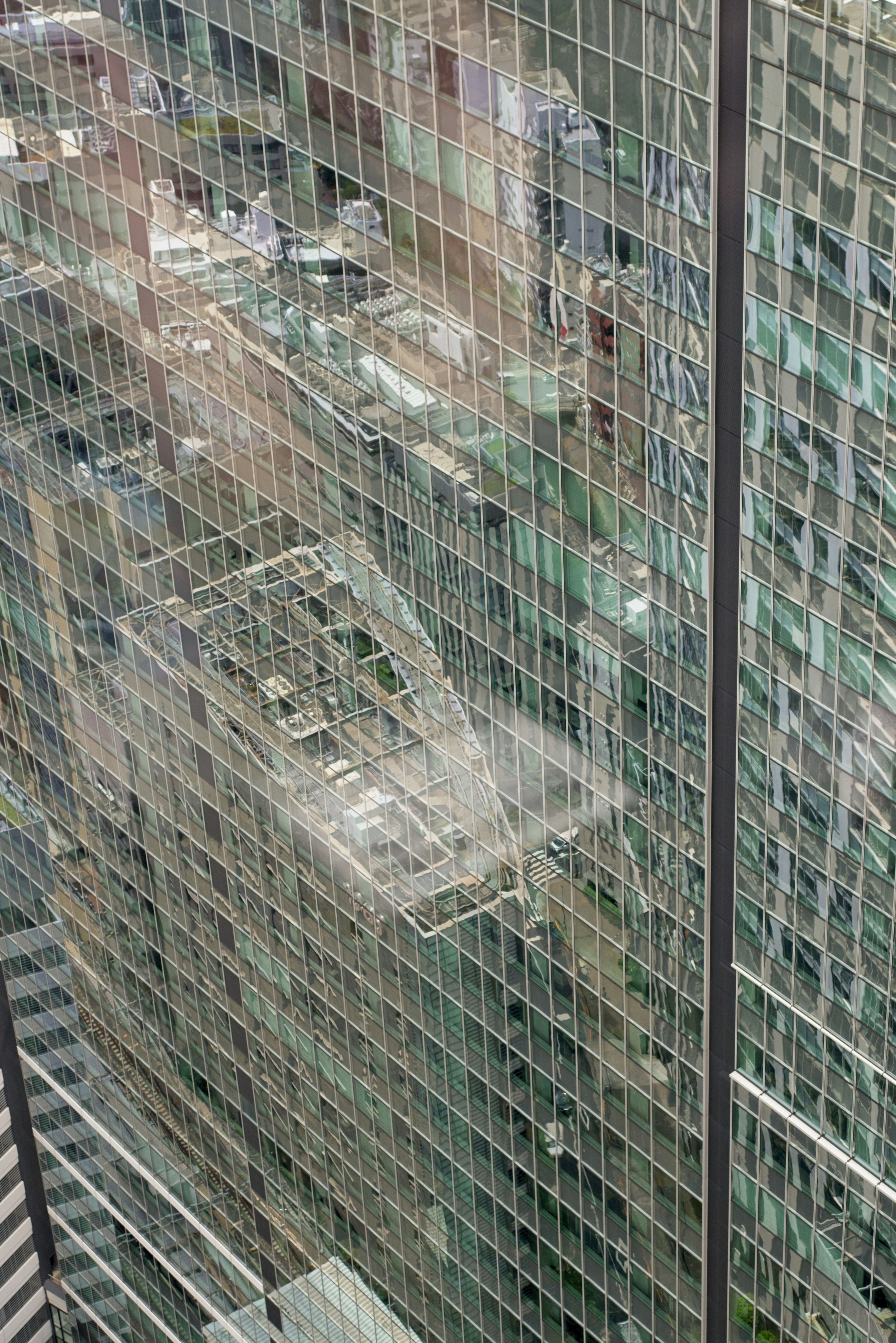Reflections in a Glass Grid: Cityscape Mosaic Beneath Tinted Facades