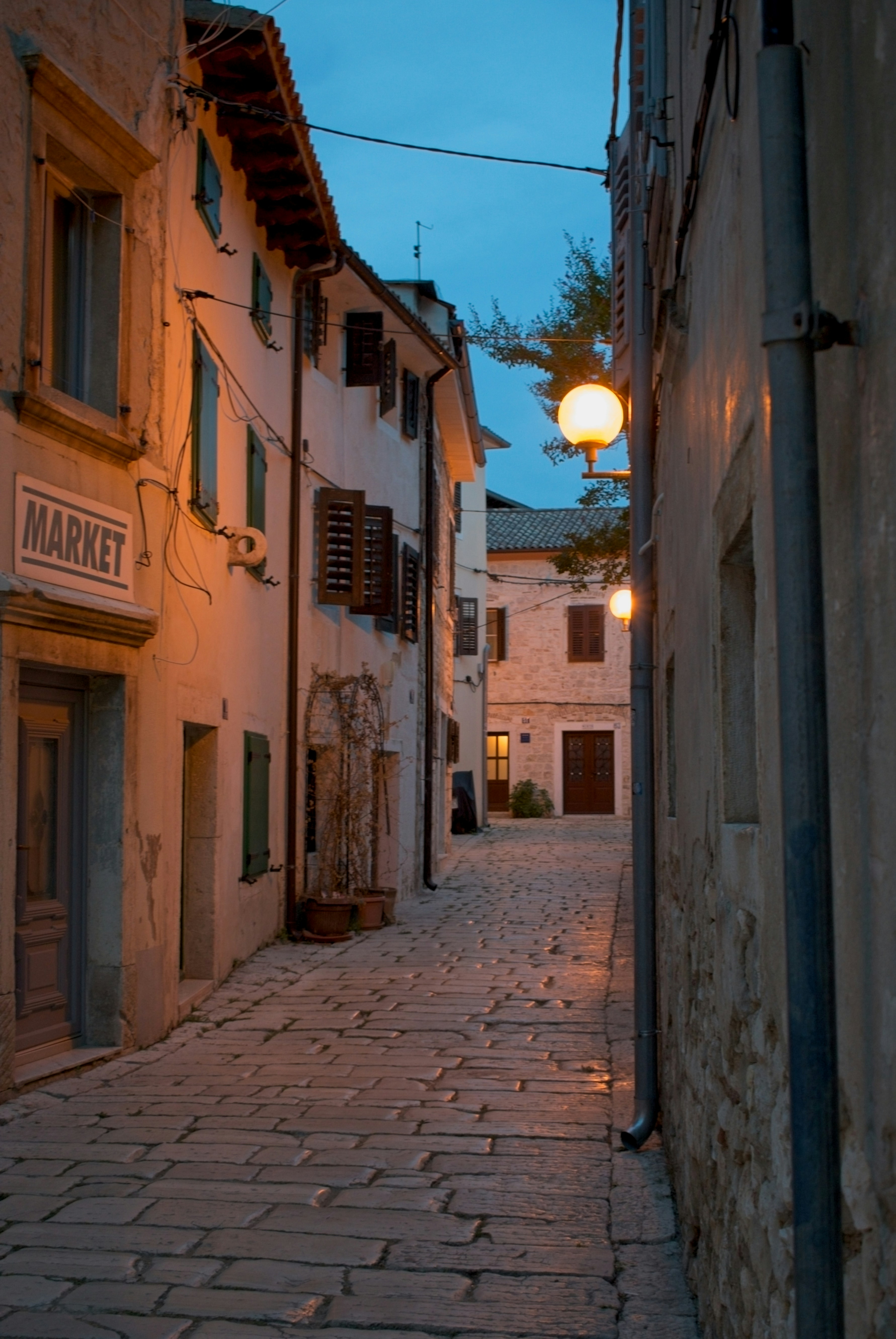 Lanterned Alleyway to a Quiet Terrace