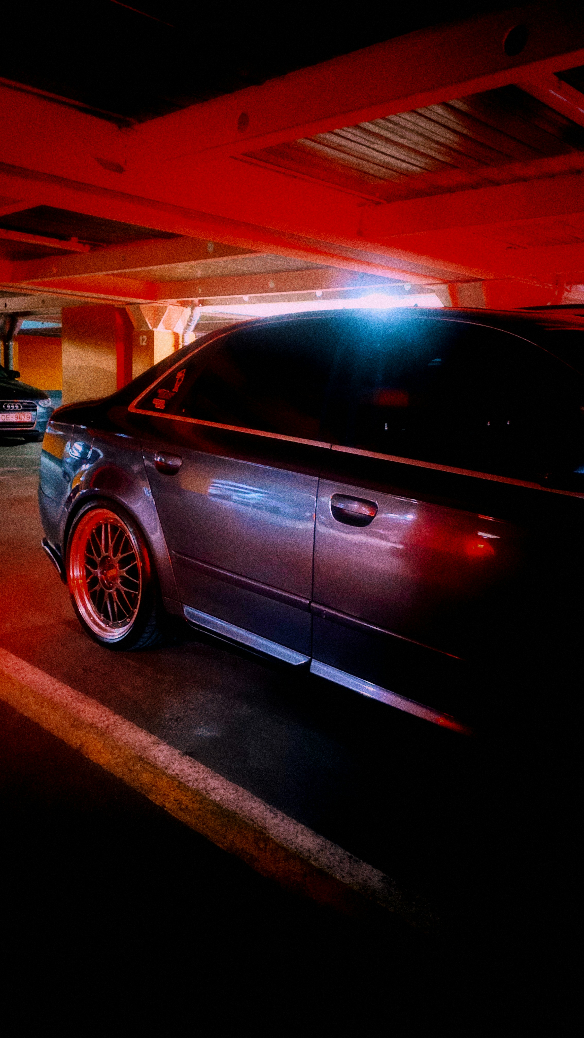Red Neon Afterglow: A Stanced Sedan in a Parking Garage