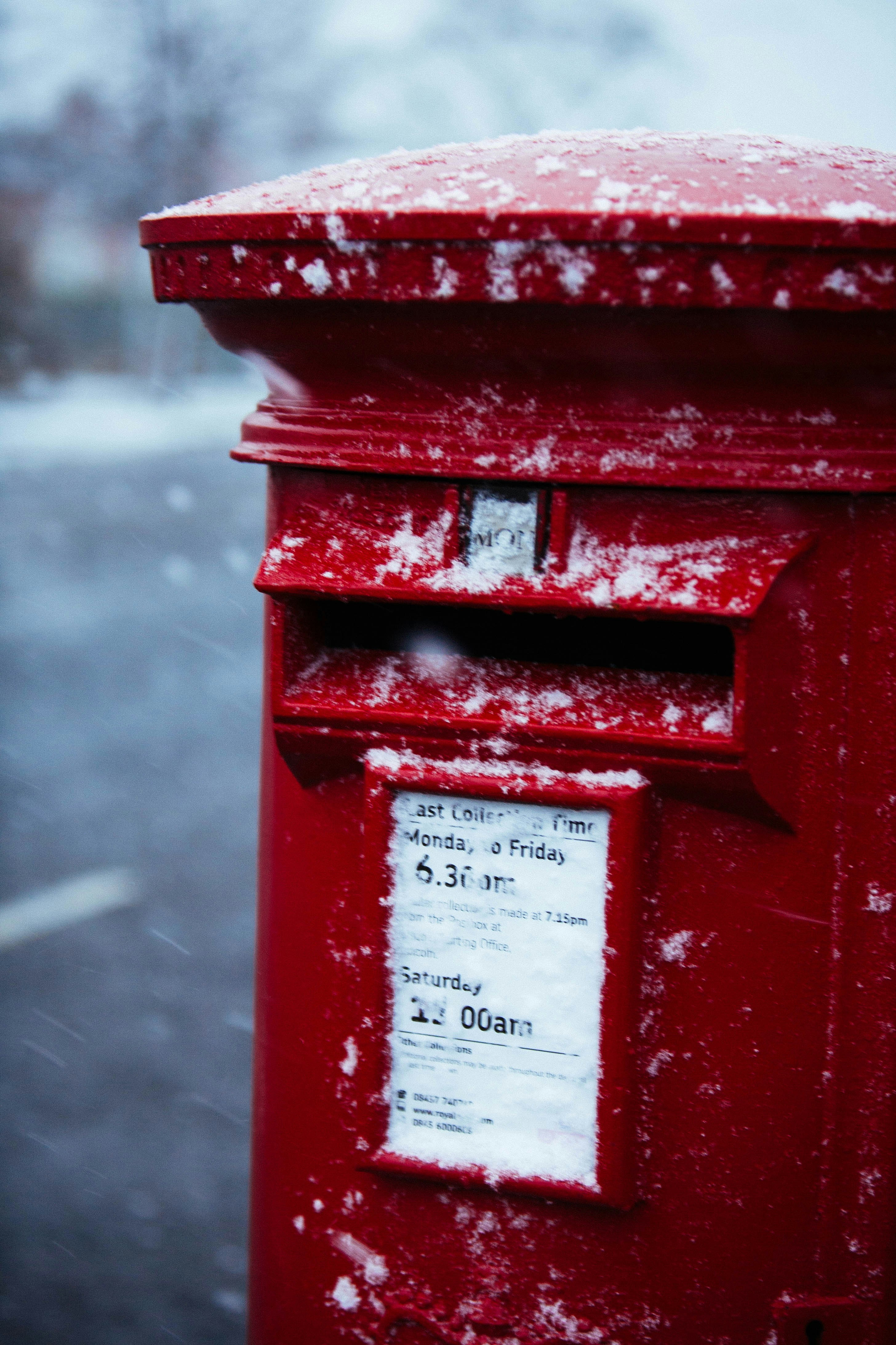 Snow-dusted Red Mailbox Standing Against a Wintry Street