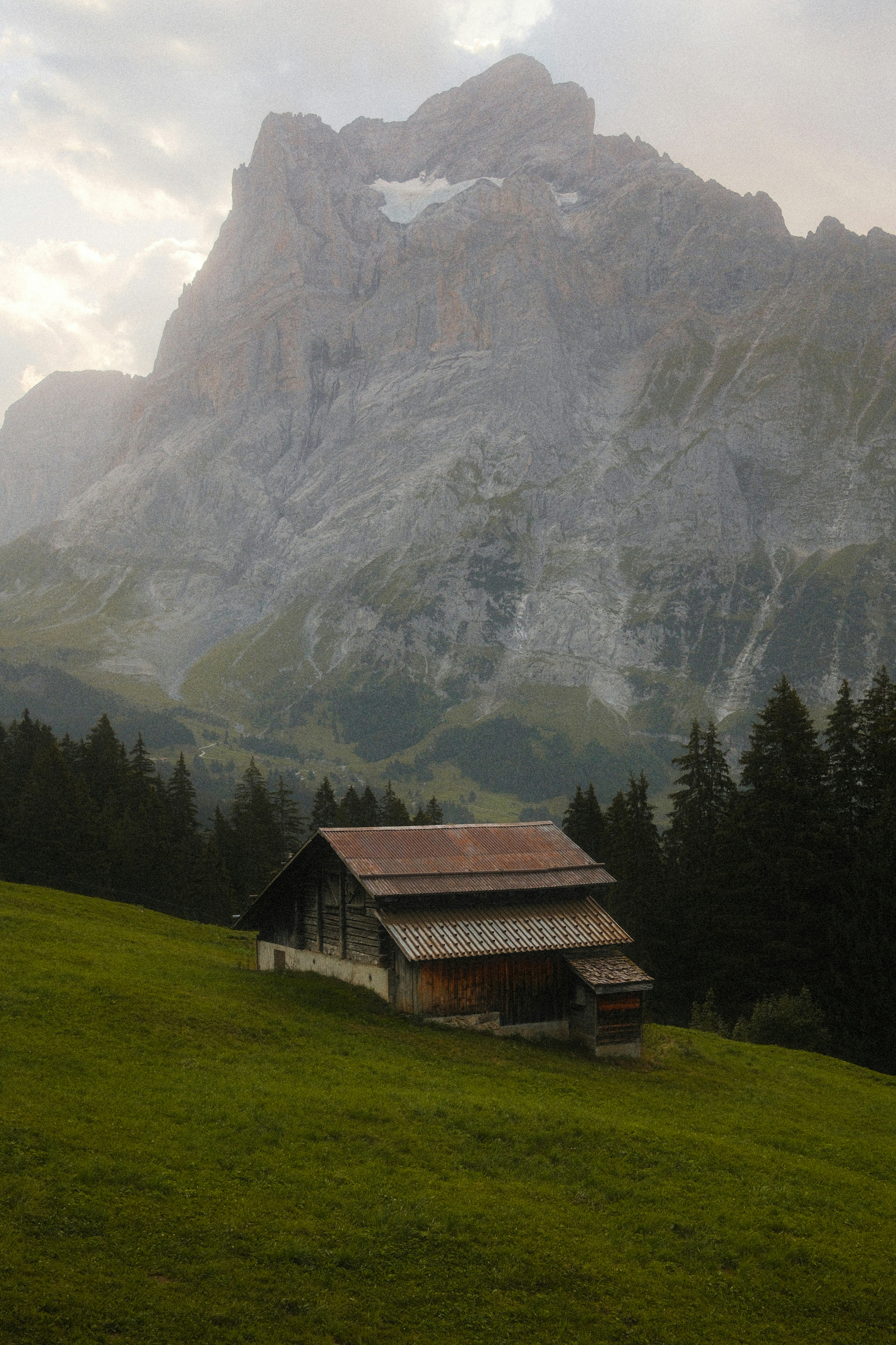 Hut Beneath Giants: A Quiet Alpine Farm with Majestic Peaks