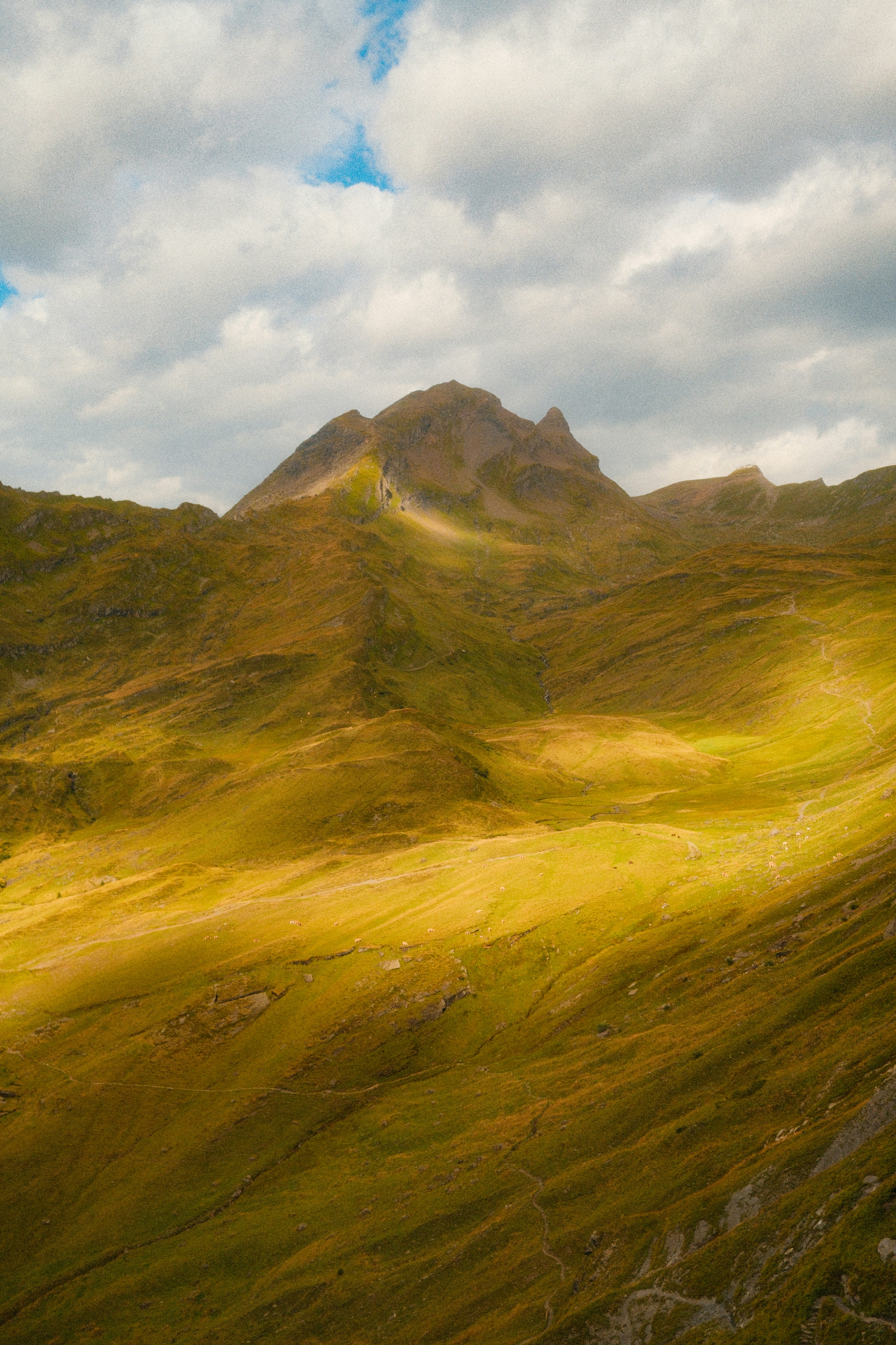 Hilltop Peak Beneath a Patchwork Sky