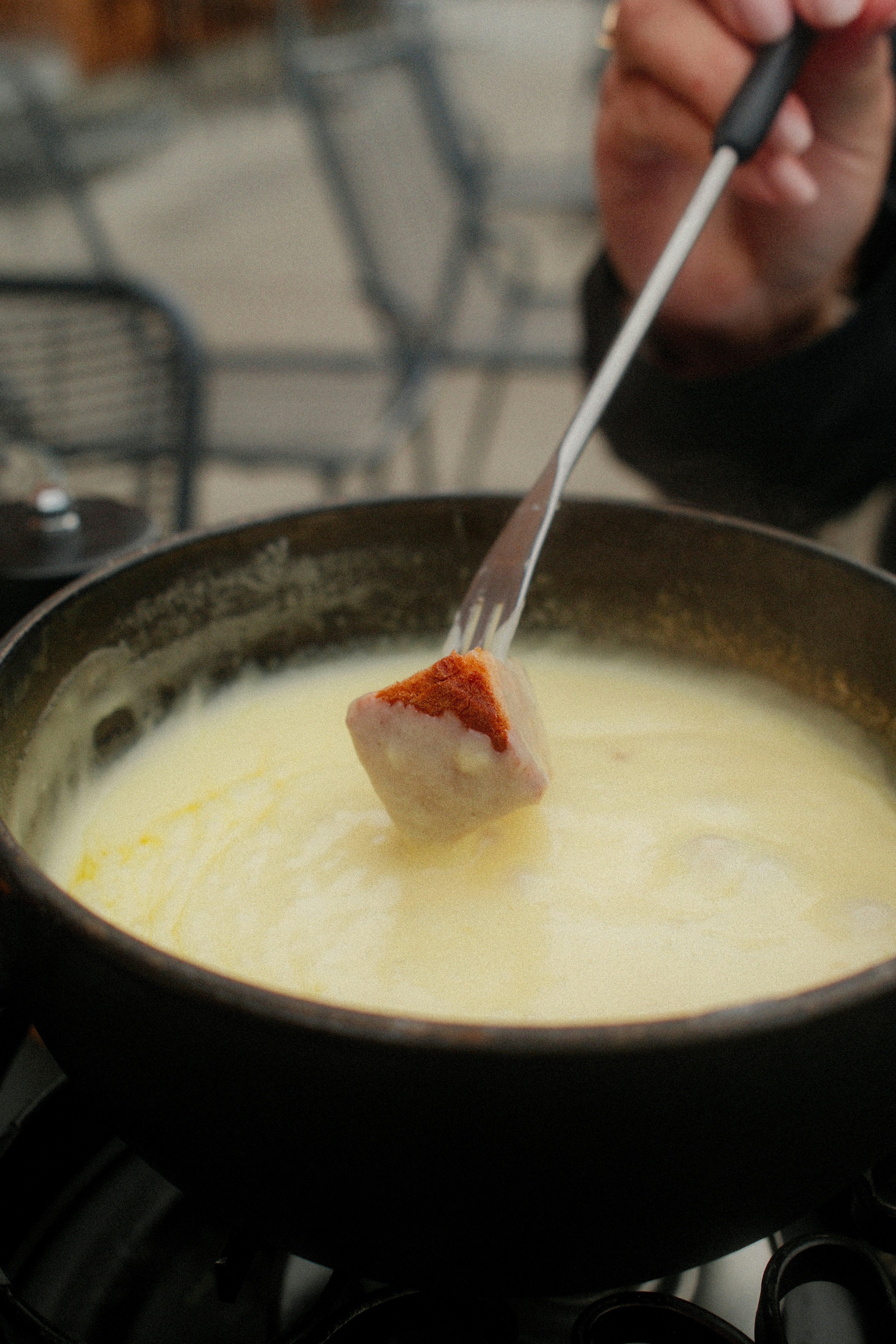 Fondue Moment: Toasted Bread Cube Dipped in Creamy Melt