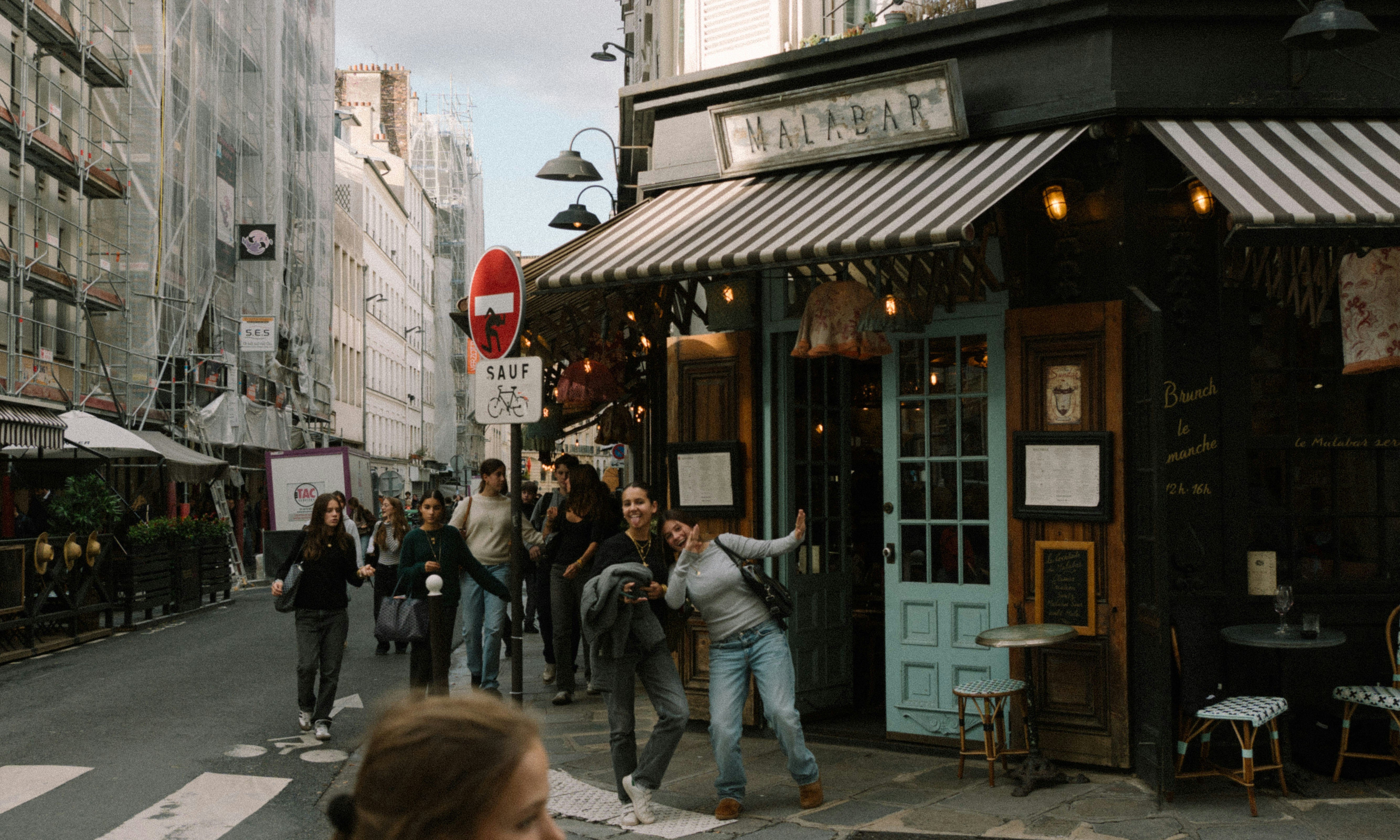 Café Corner Crowd: A Stride Through a Parisian-Style Street
