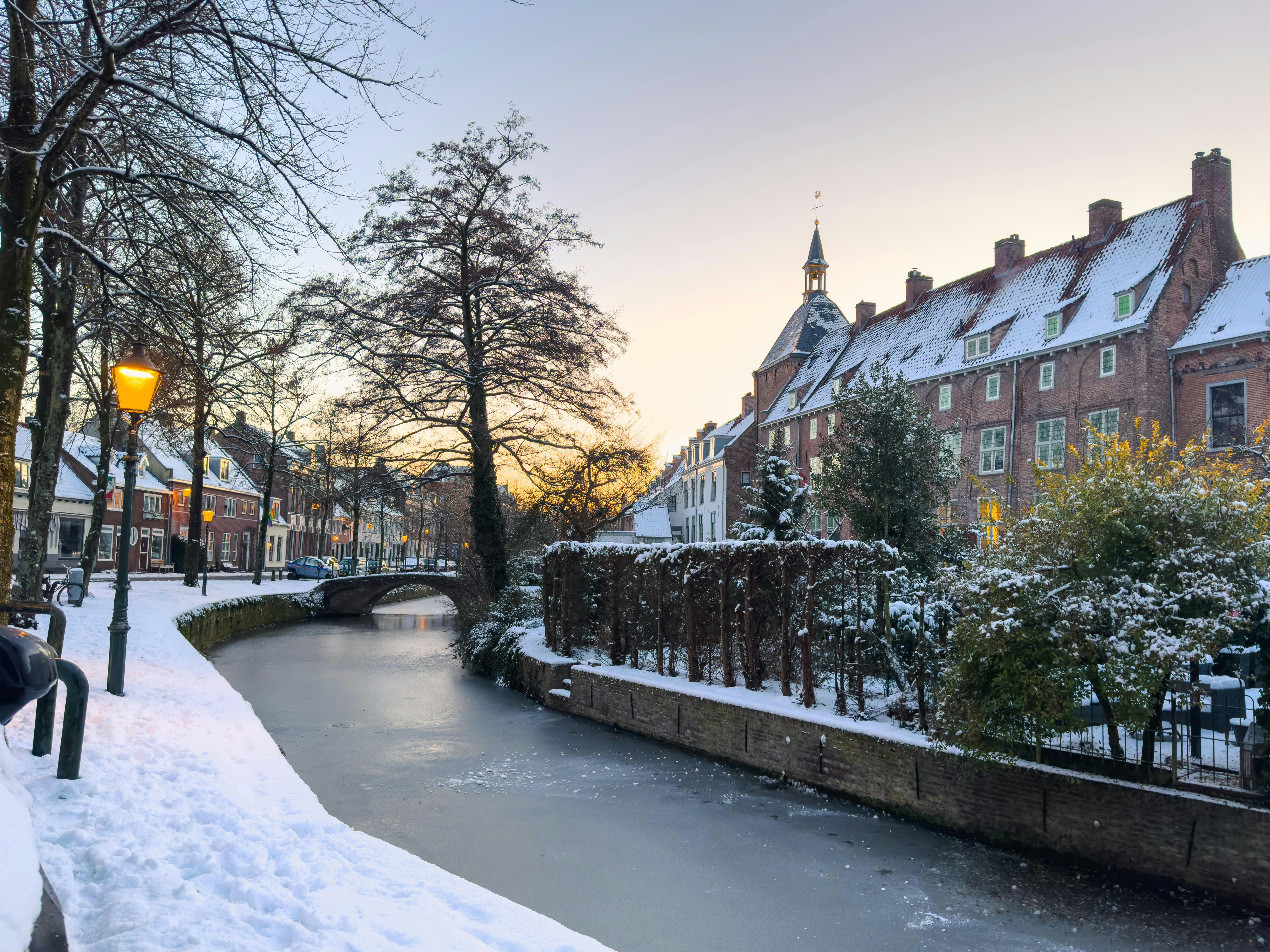 Sunlit Canal of Winter Quiet in a Dutch-esque Town