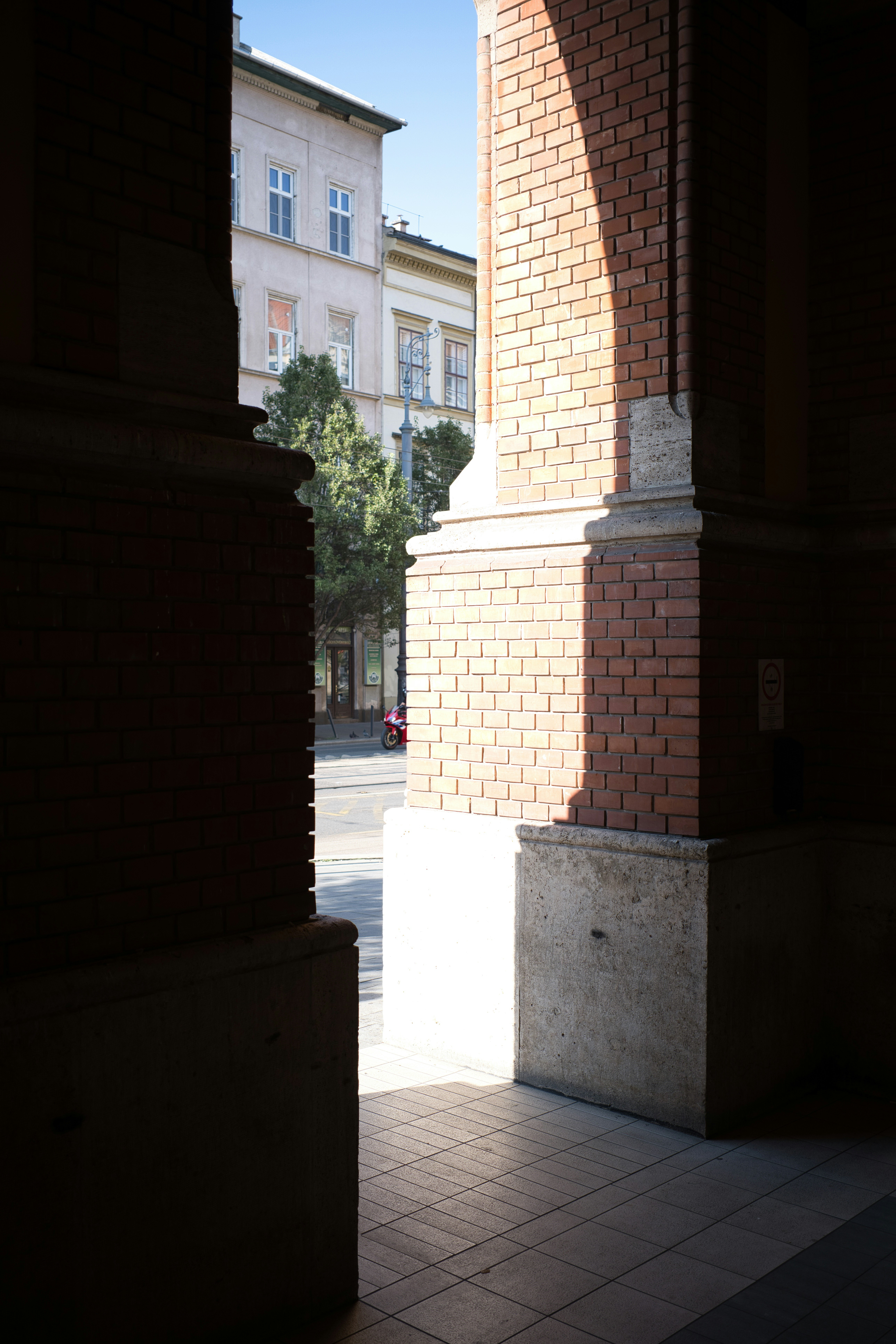 Sunlit Archway Frames a Quiet City Moment