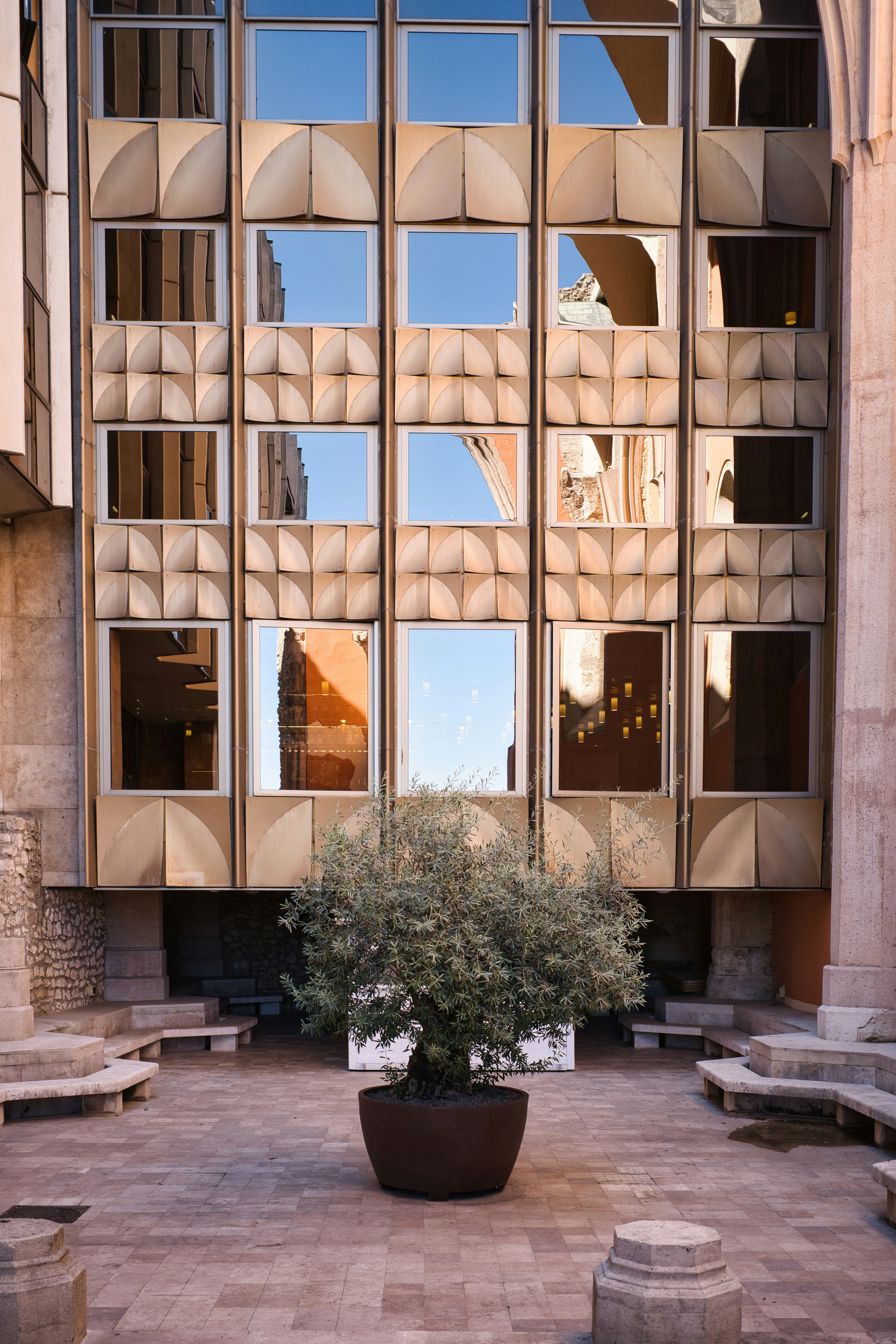 Archway Reflection: A Courtyard Portrait Framed by Geometric Facades