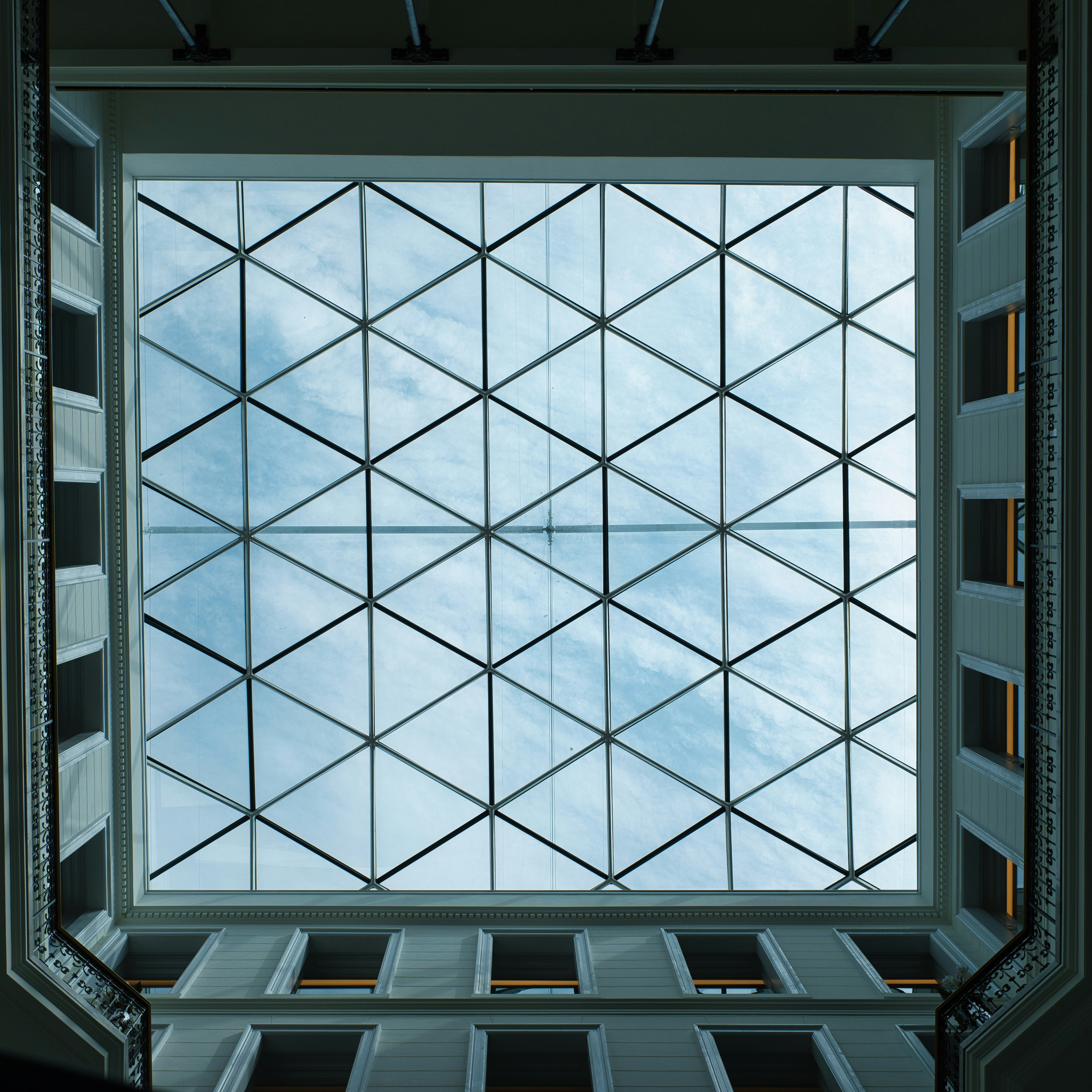 Geometric Skyward: A Courtyard of Glazed Angles