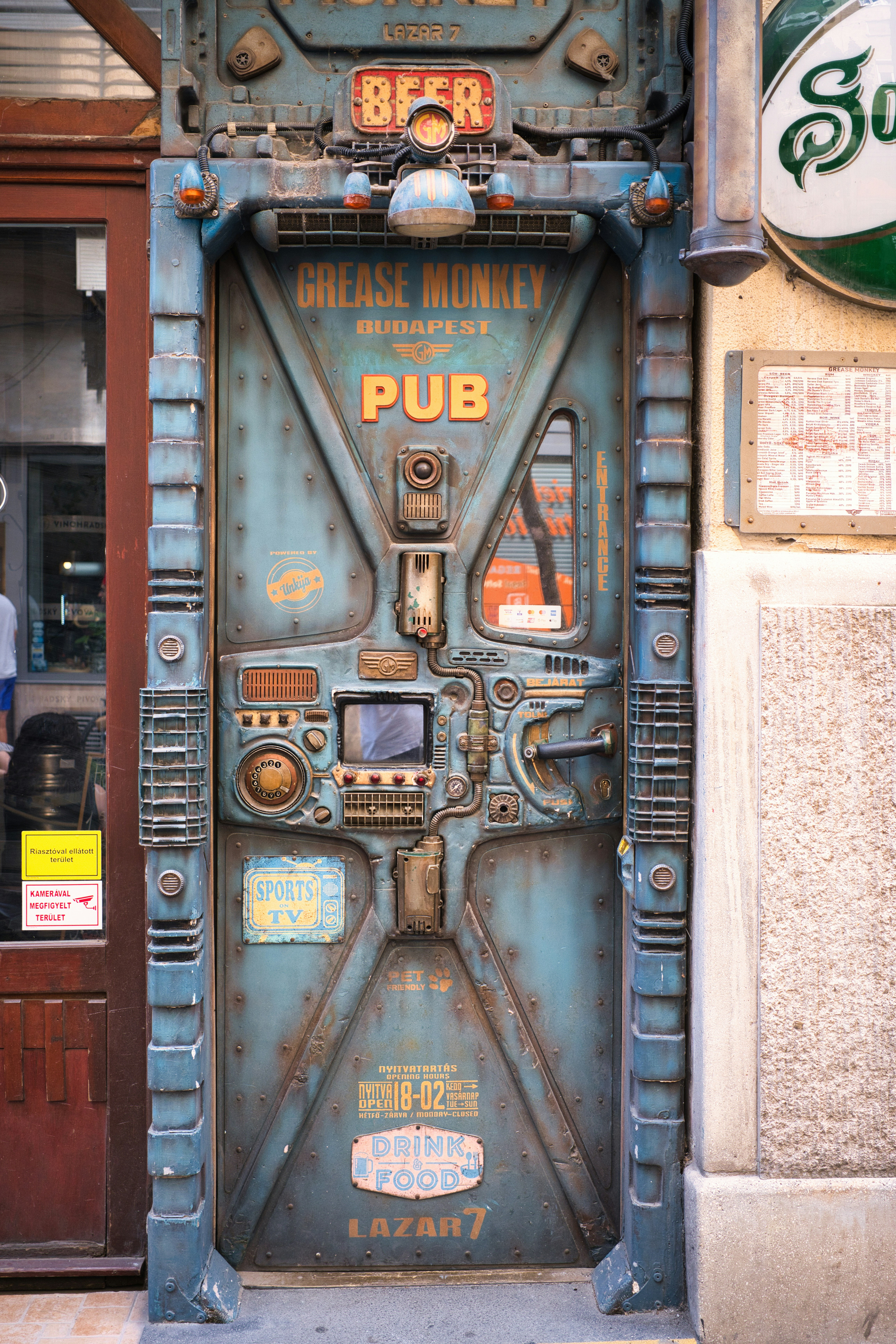 Grease Monkey Pub Door: A Rusted Portal to Budapest’s Vibe