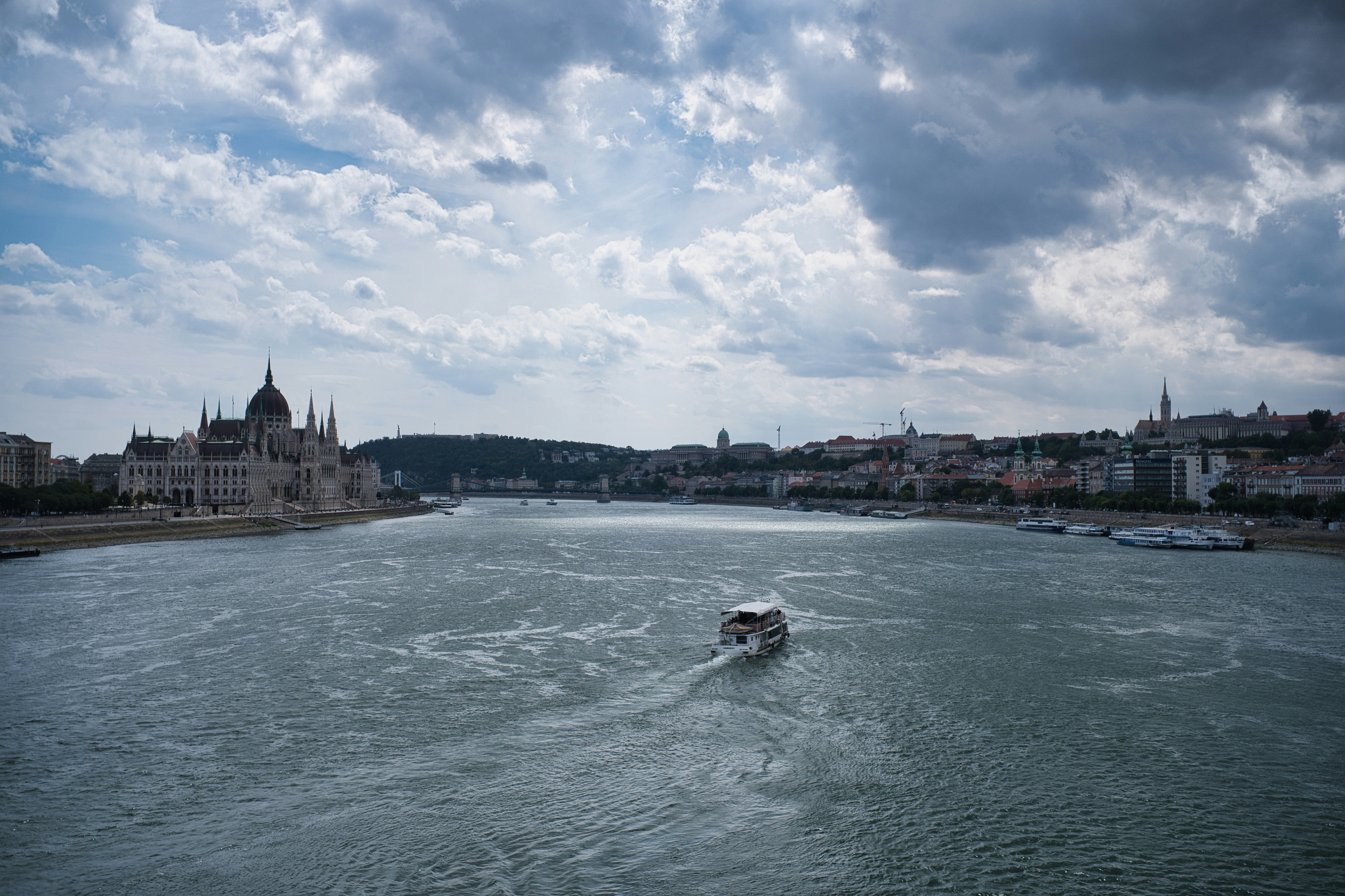 Rush of the Danube: a boat breaks the quiet at the river bend